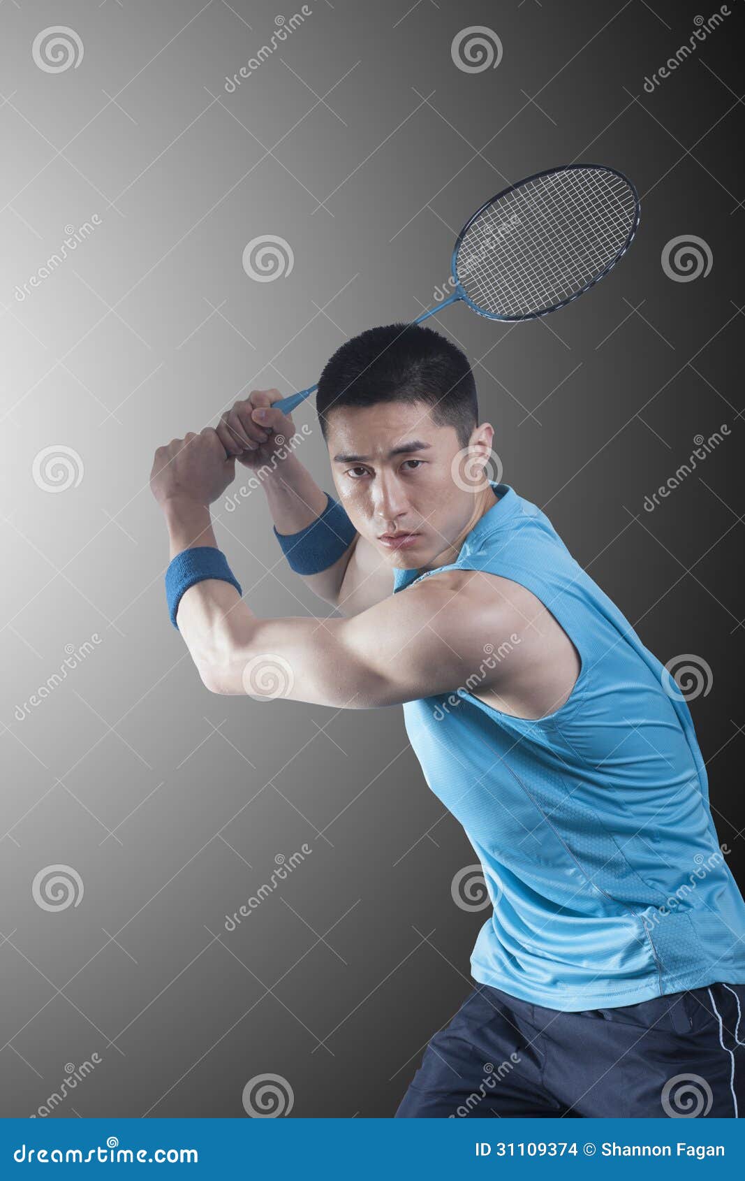Concentrated Young Man Playing Badminton, Racket Raised Stock Photo ...