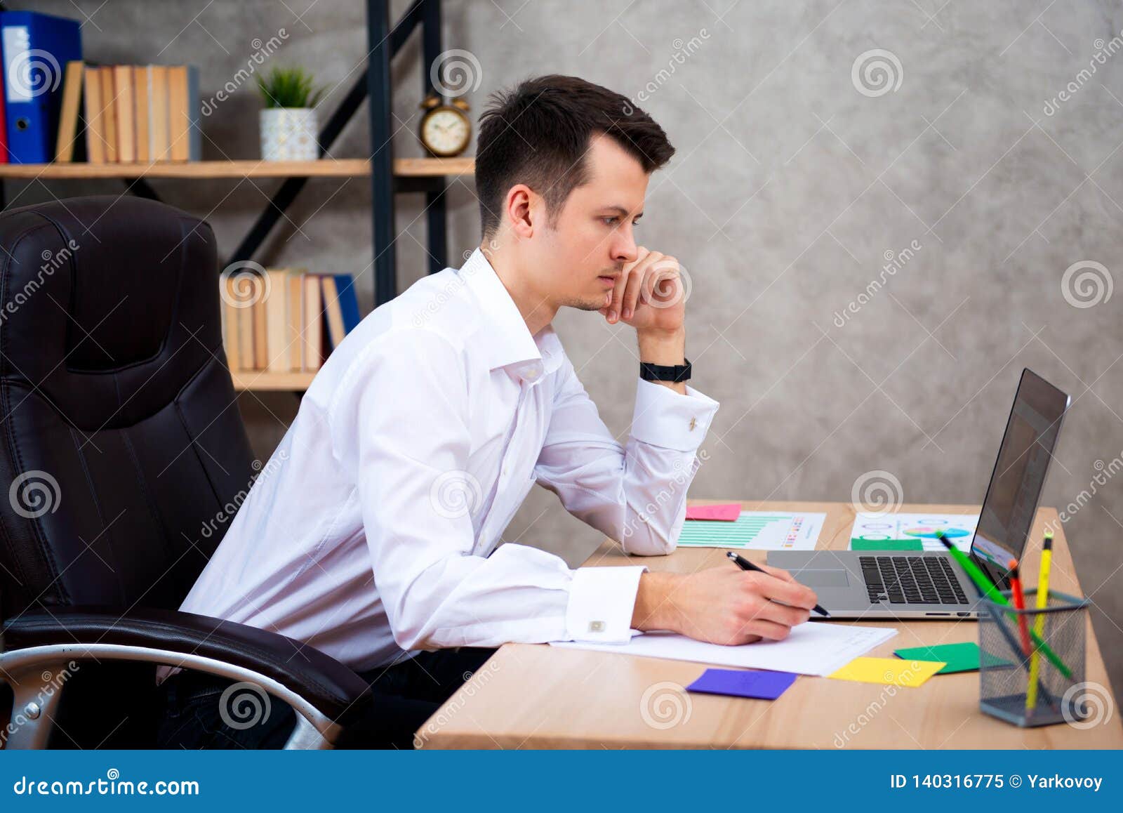 Concentrated Young Manager Man Sitting at Office Desk Working on Laptop ...