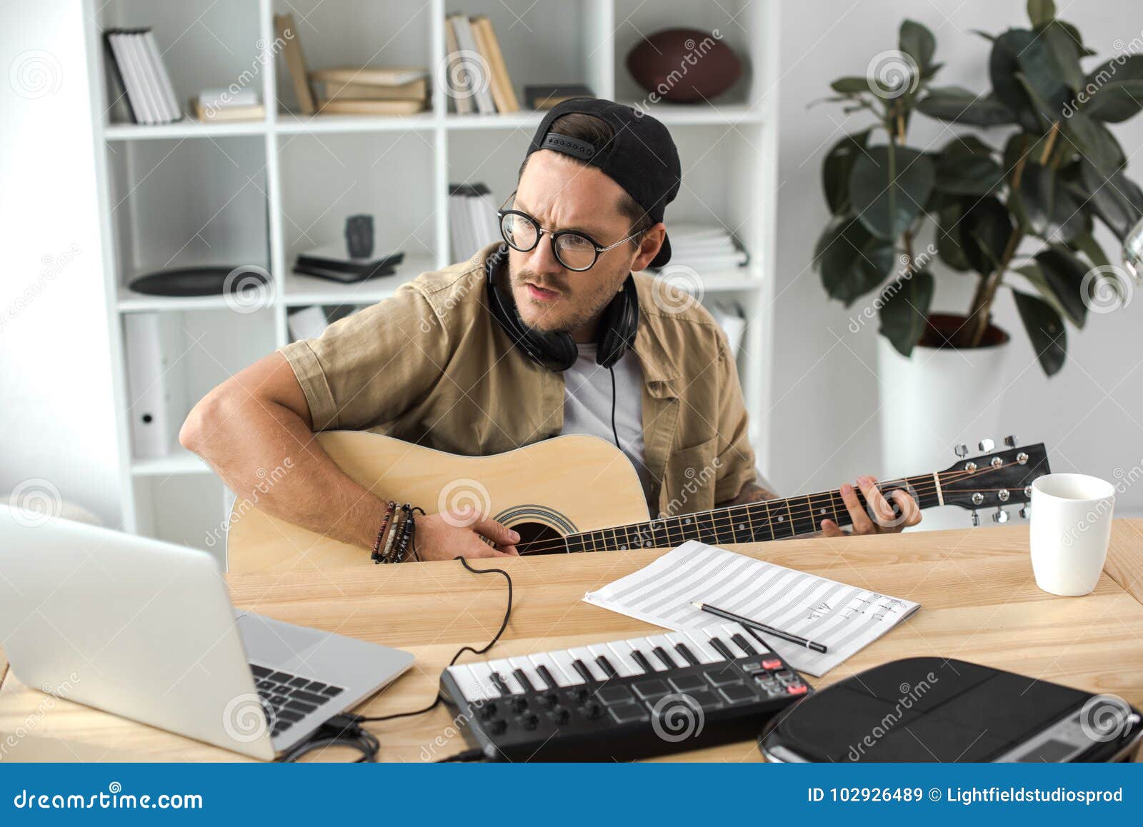 Musician playing guitar stock image. Image of headphones - 102926489
