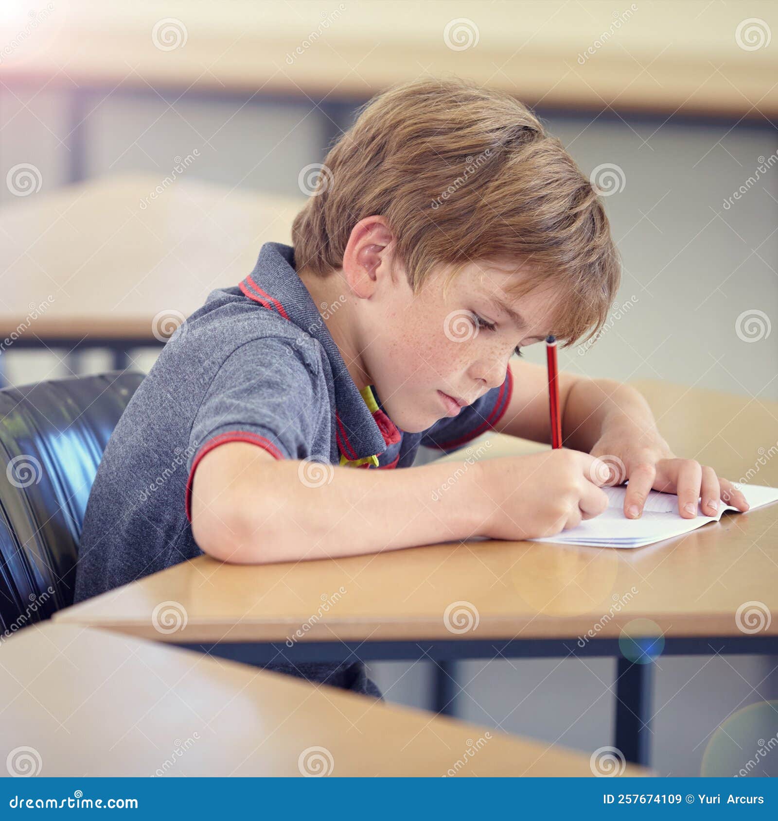 Concentrating on His Classwork. a Little Boy Doing His Work in Class ...