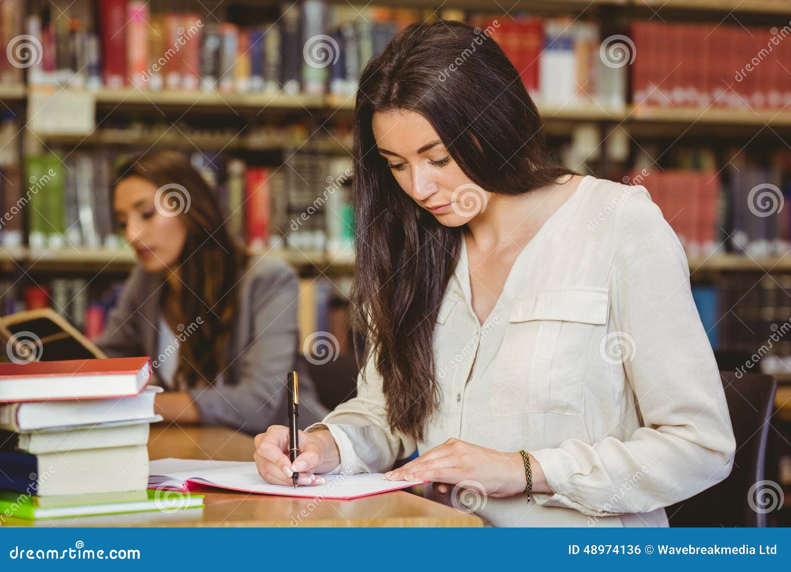 Concentrating Pretty Brunette Student Writing in Notepad Stock Photo ...