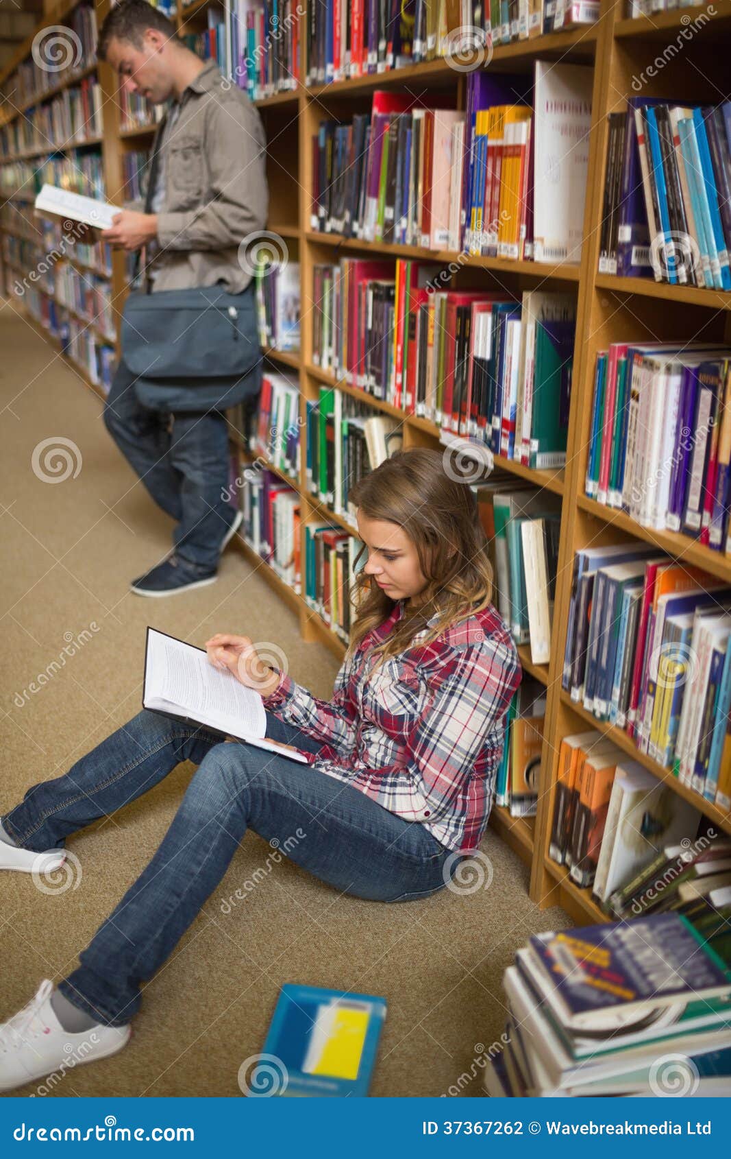 Concentrating Student Reading Book on Library Floor Stock Photo - Image ...