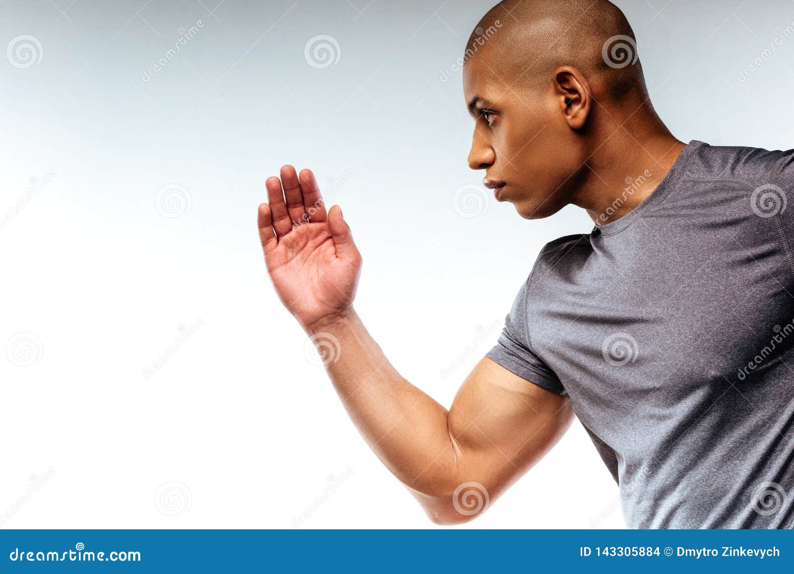 Concentrated Man Demonstrating His Power while Doing Sports Stock Photo ...