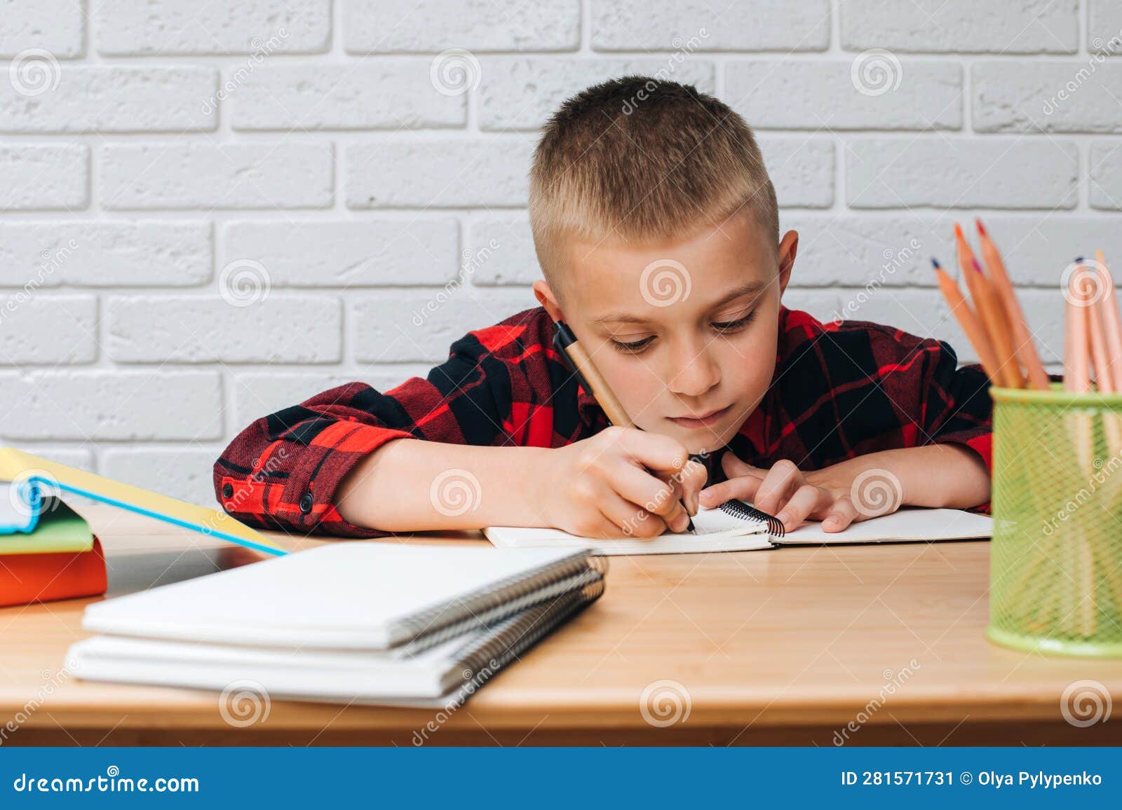Concept Back To the School. a Boy in the Process of Studying Sits at a ...