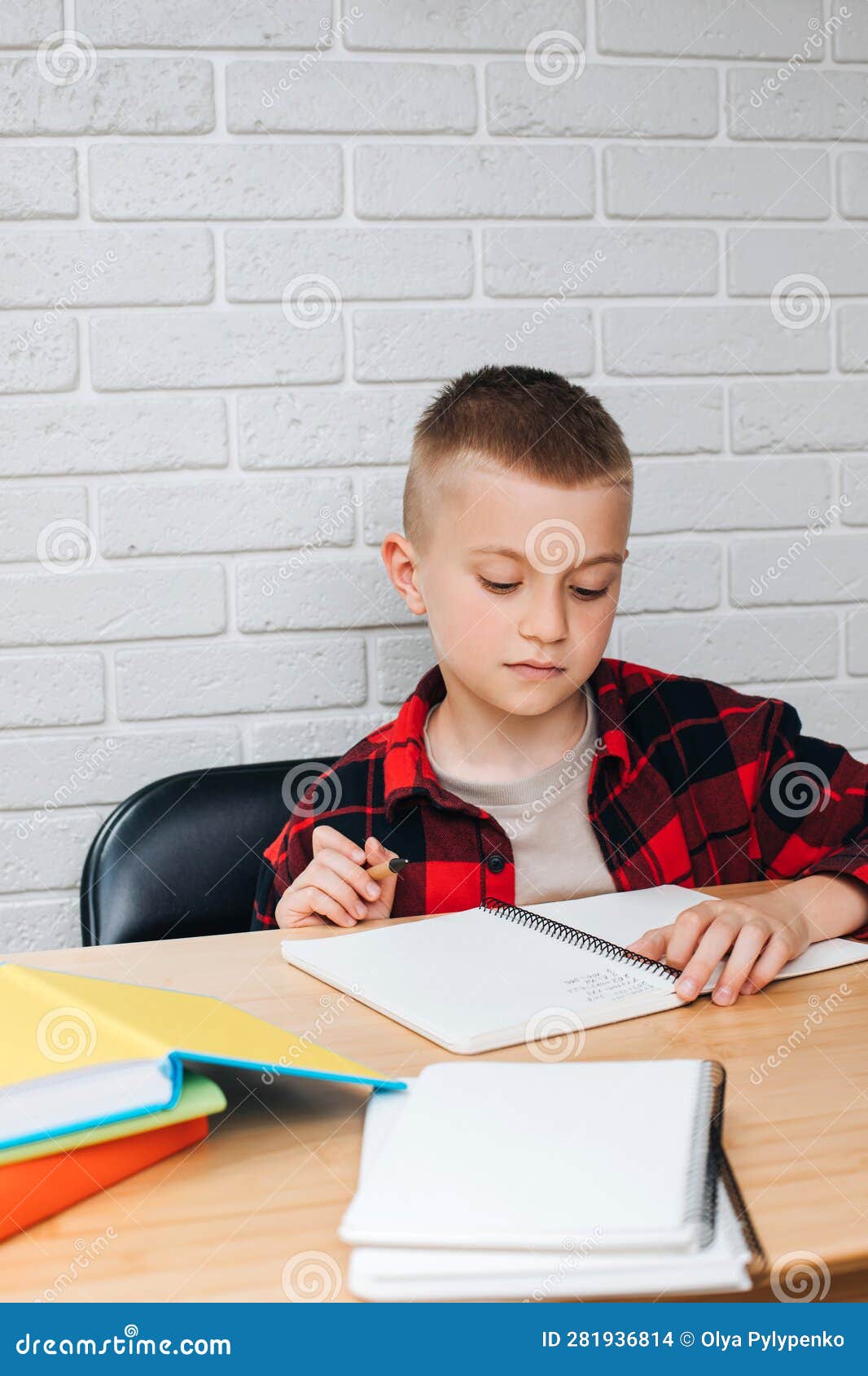 Concept Back To the School. a Boy in the Process of Studying Sits at a ...