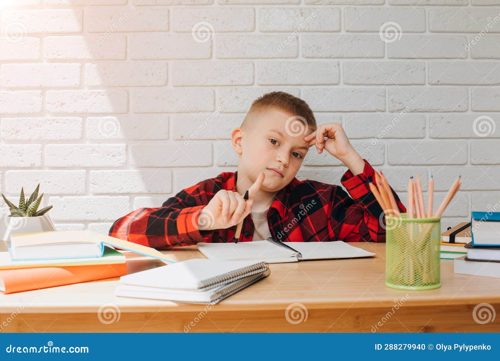 Concept Back To the School. a Boy in the Process of Studying Sits at a ...