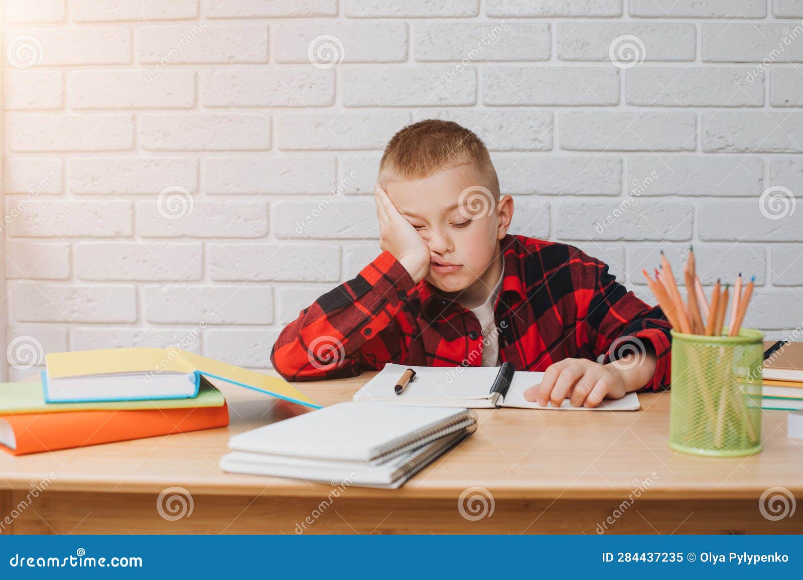 Concept Back To the School. a Boy in the Process of Studying Sits at a ...