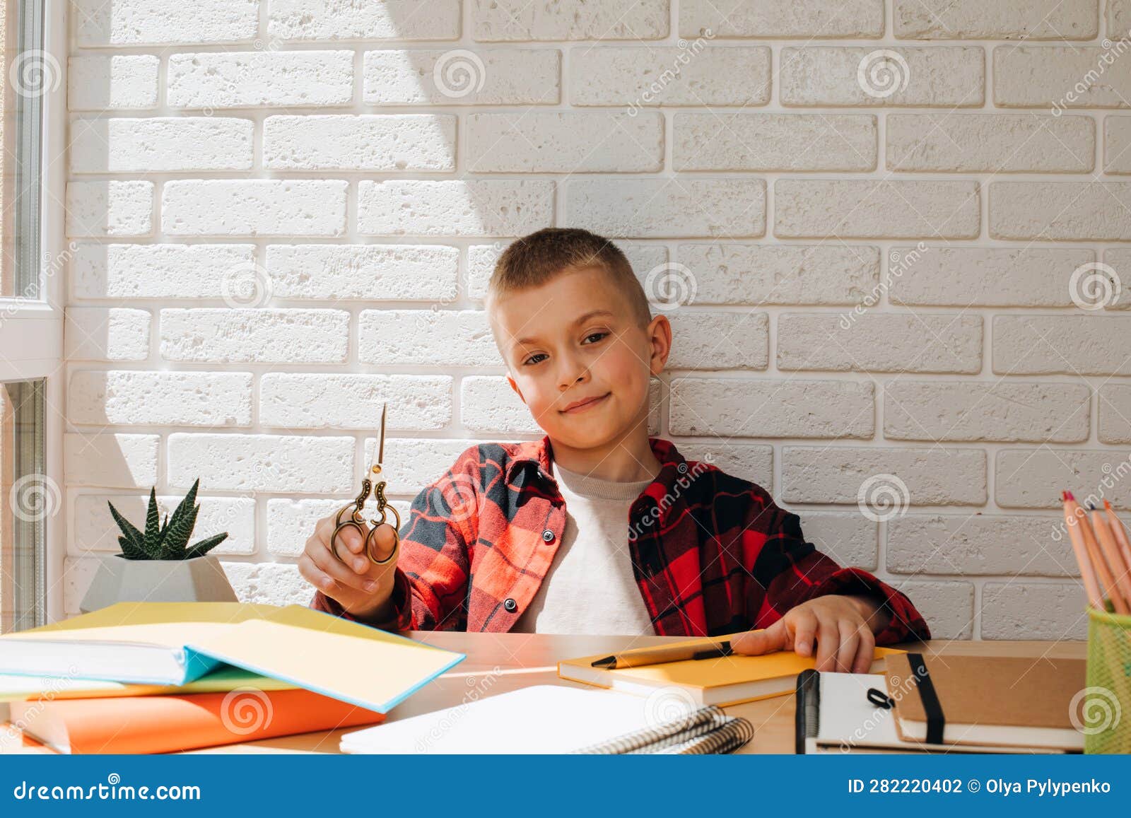 Concept Back To the School. a Boy in the Process of Studying Sits at a ...