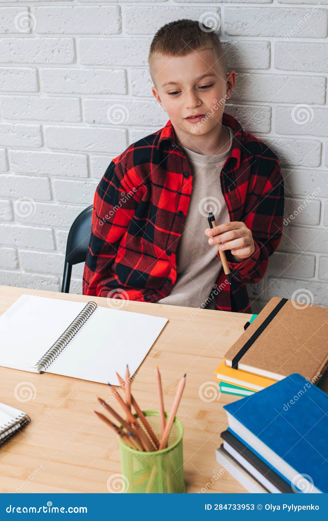 Concept Back To the School. a Boy in the Process of Studying Sits at a ...