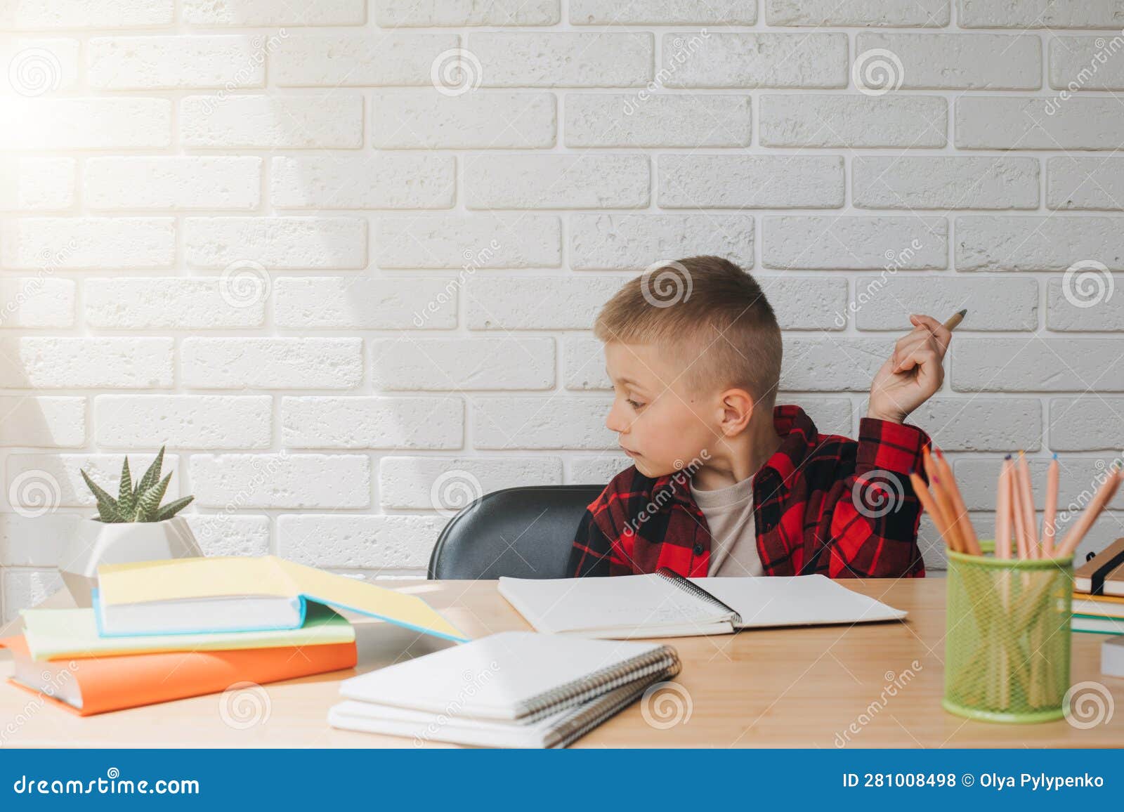 Concept Back To the School. a Boy in the Process of Studying Sits at a ...