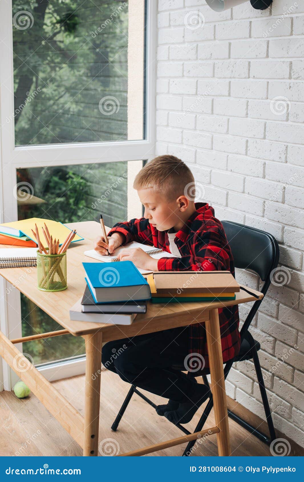 Concept Back To the School. a Boy in the Process of Studying Sits at a ...