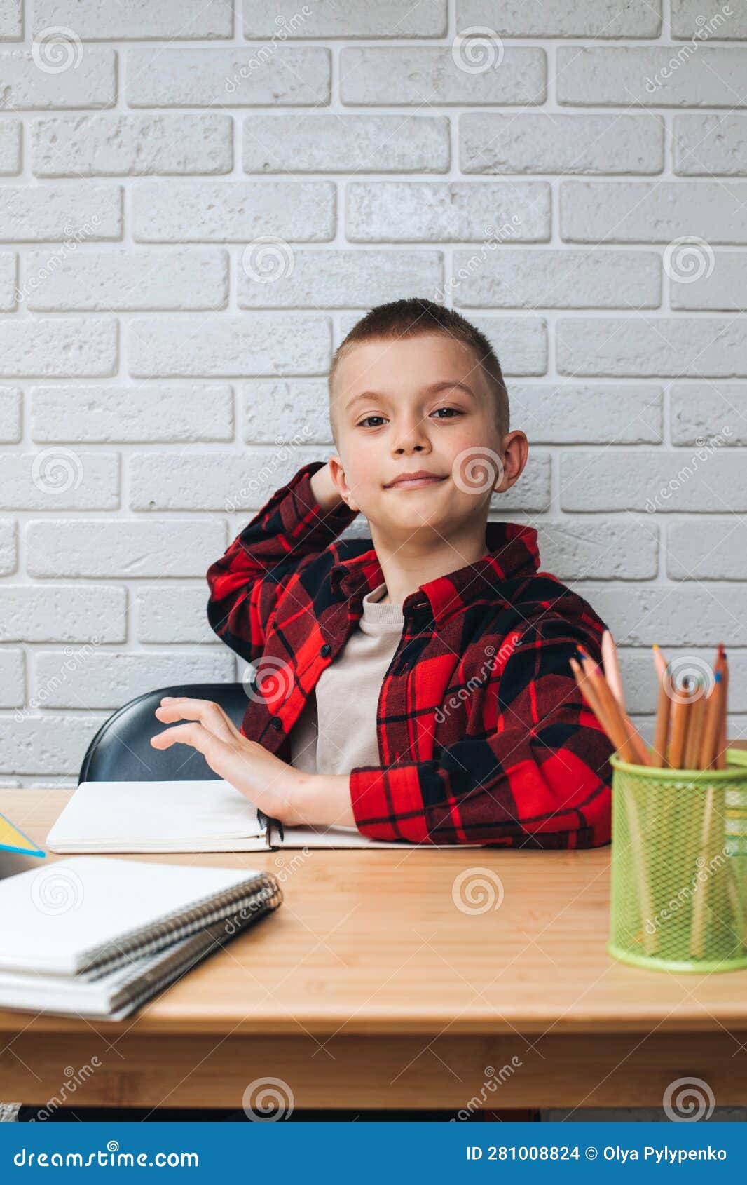 Concept Back To the School. a Boy in the Process of Studying Sits at a ...