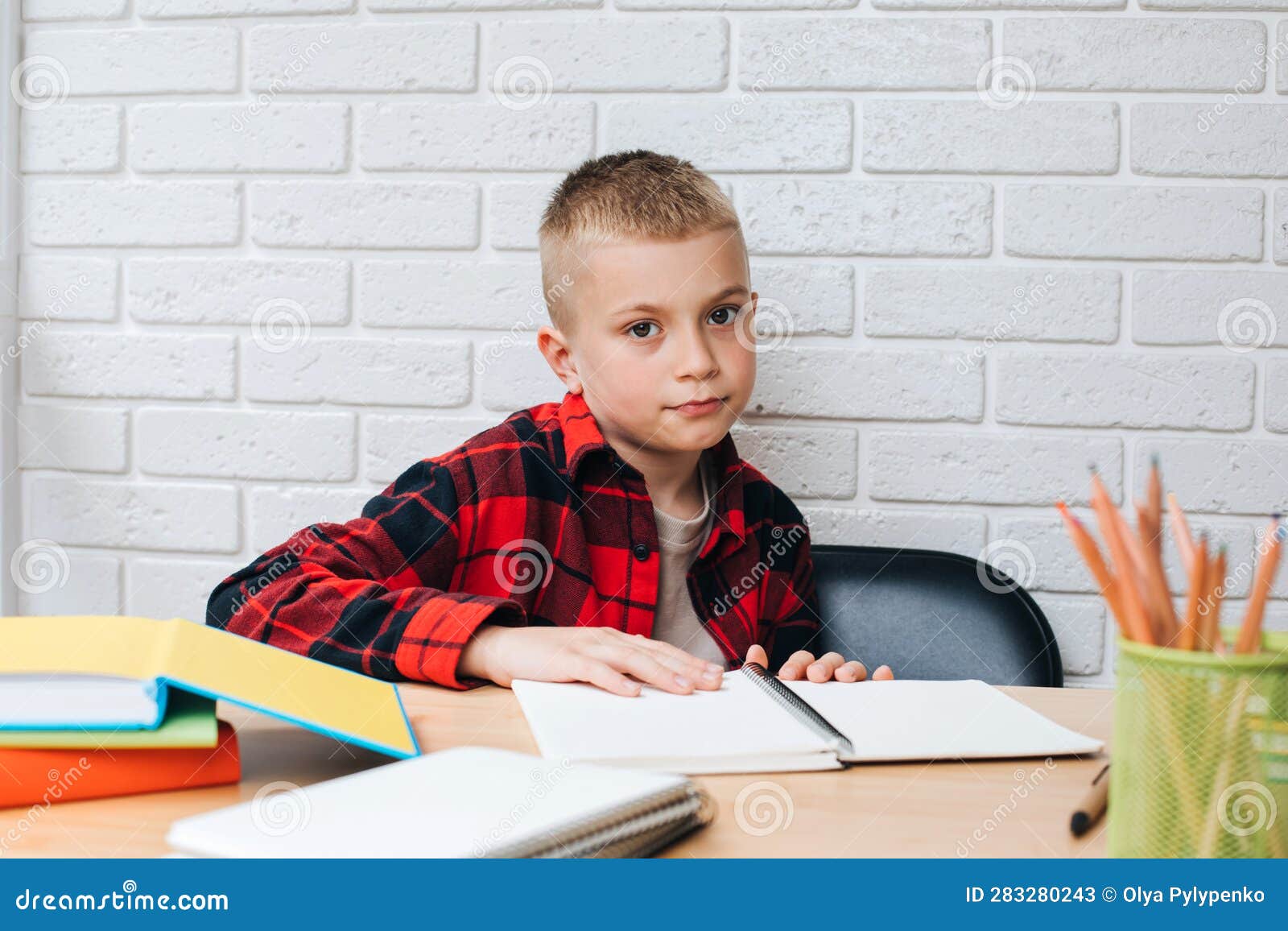 Concept Back To the School. a Boy in the Process of Studying Sits at a ...