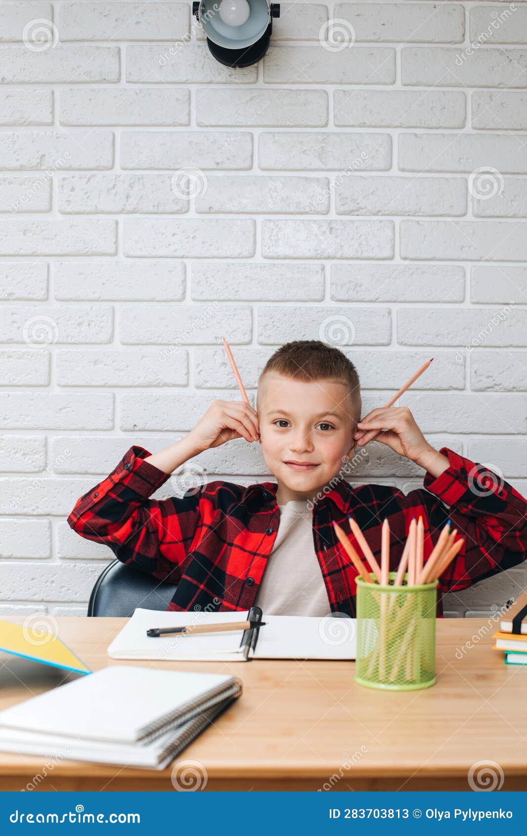 Concept Back To the School. a Boy in the Process of Studying Sits at a ...