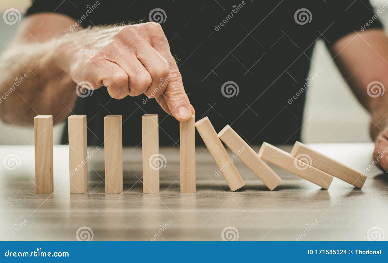 Concept of Business Control by Stopping Domino Effect Stock Photo ...
