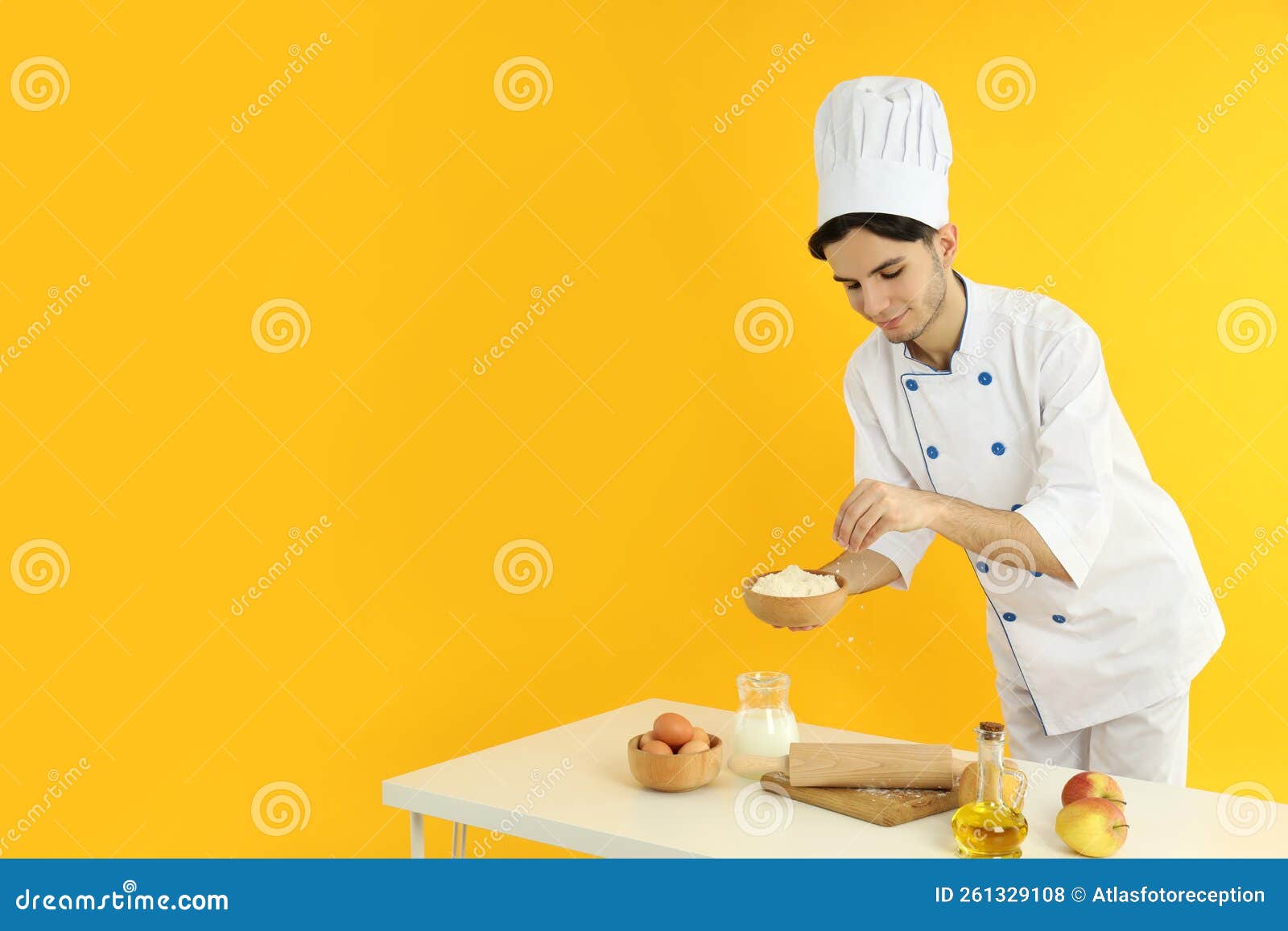 Concept of Cooking, Young Man Chef on Yellow Background Stock Photo ...