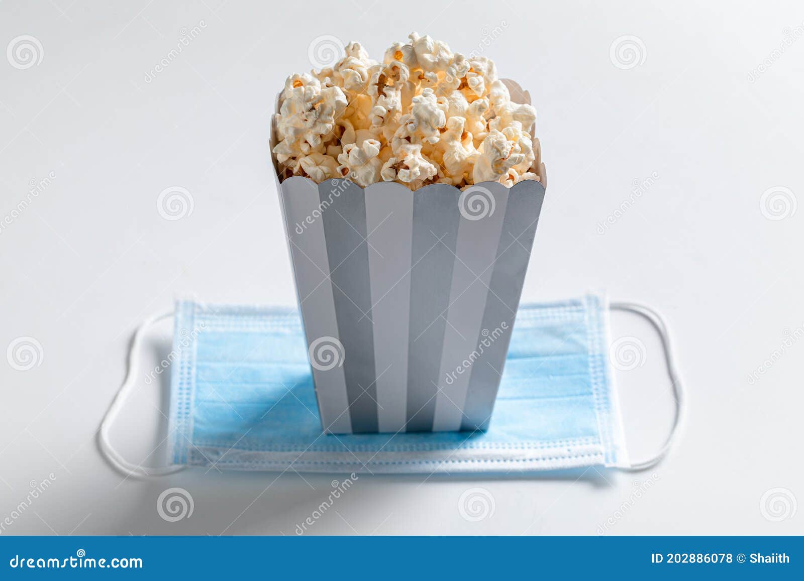 Concept of COVID-19 and Protective in Cinema. Popcorn and Mask Stock ...