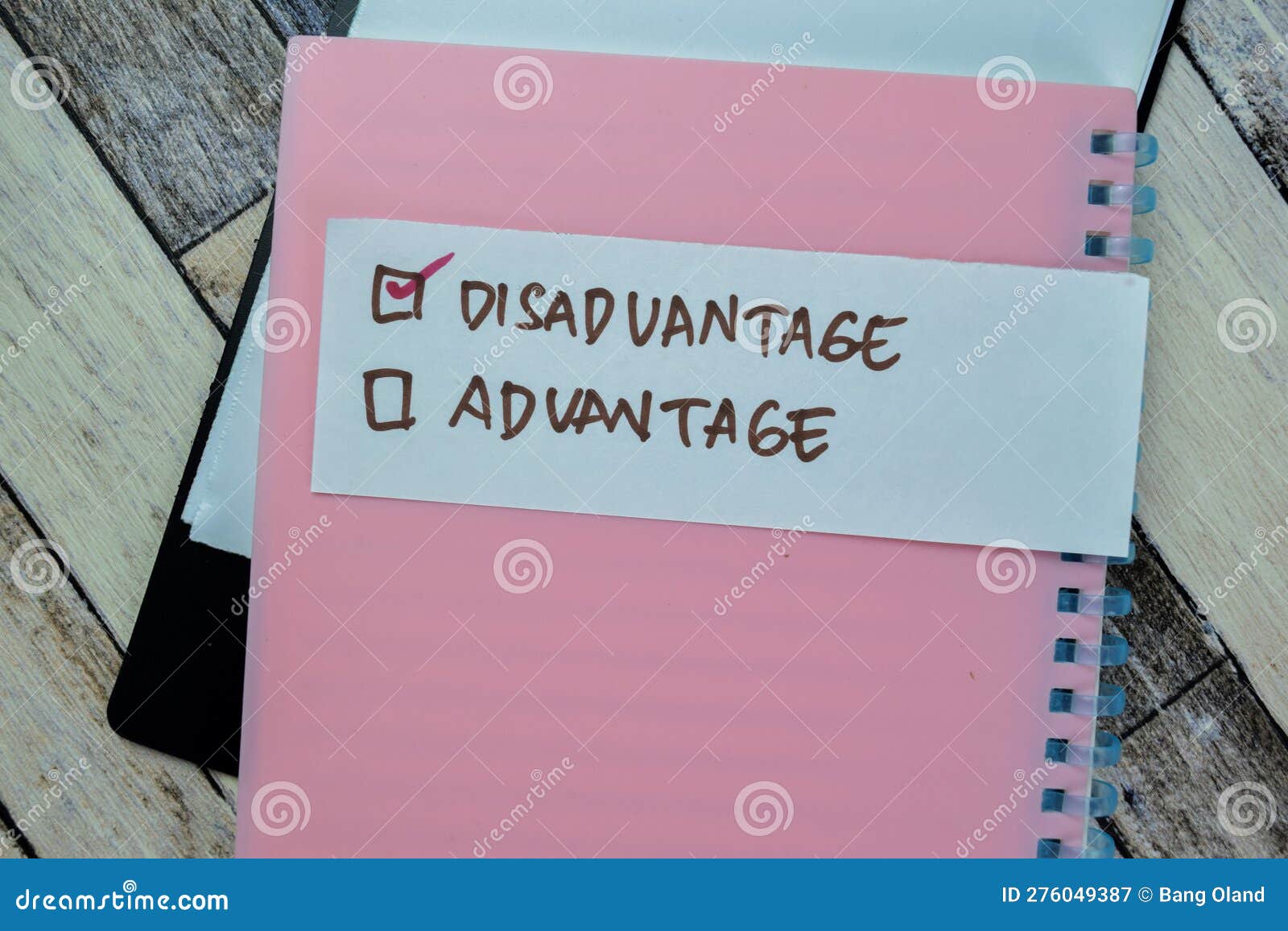 Concept Of Disadvantage Write On Sticky Notes Isolated On Wooden Table