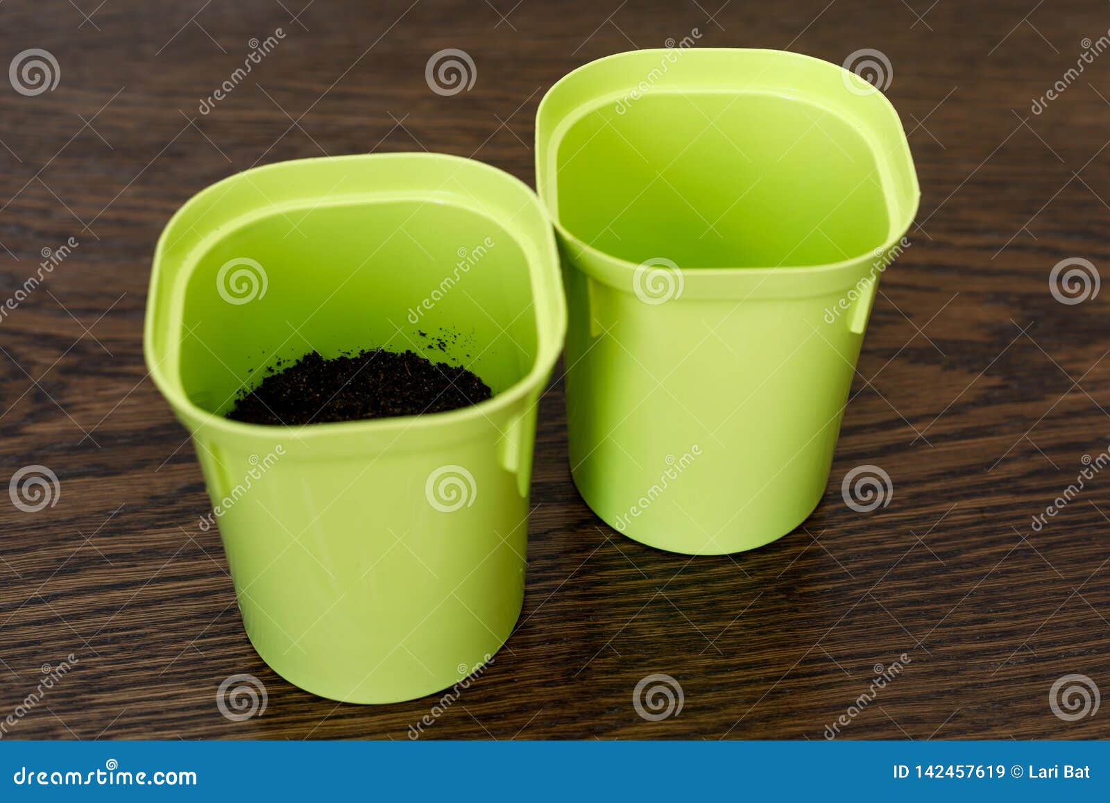 Two Plastic Flower Pots, One Half Filled with Earth, the Second Empty ...