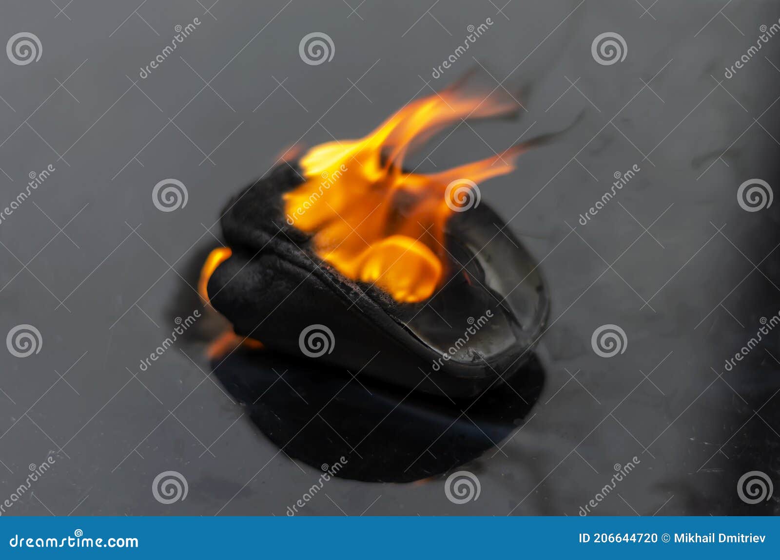 Concept of Fire Safety. Burning Wireless Computer Mouse on a Black ...