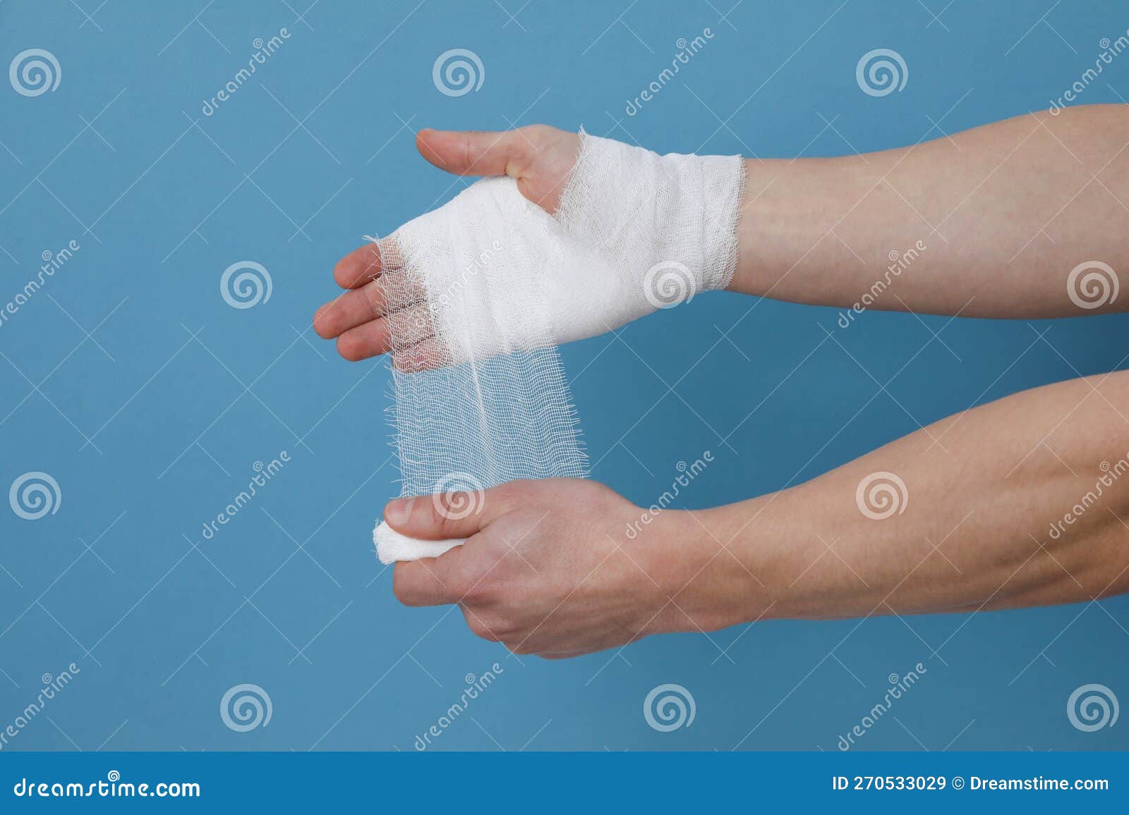 Concept of Help during an Injury, Man Wrapping Hand in Bandage on Blue ...
