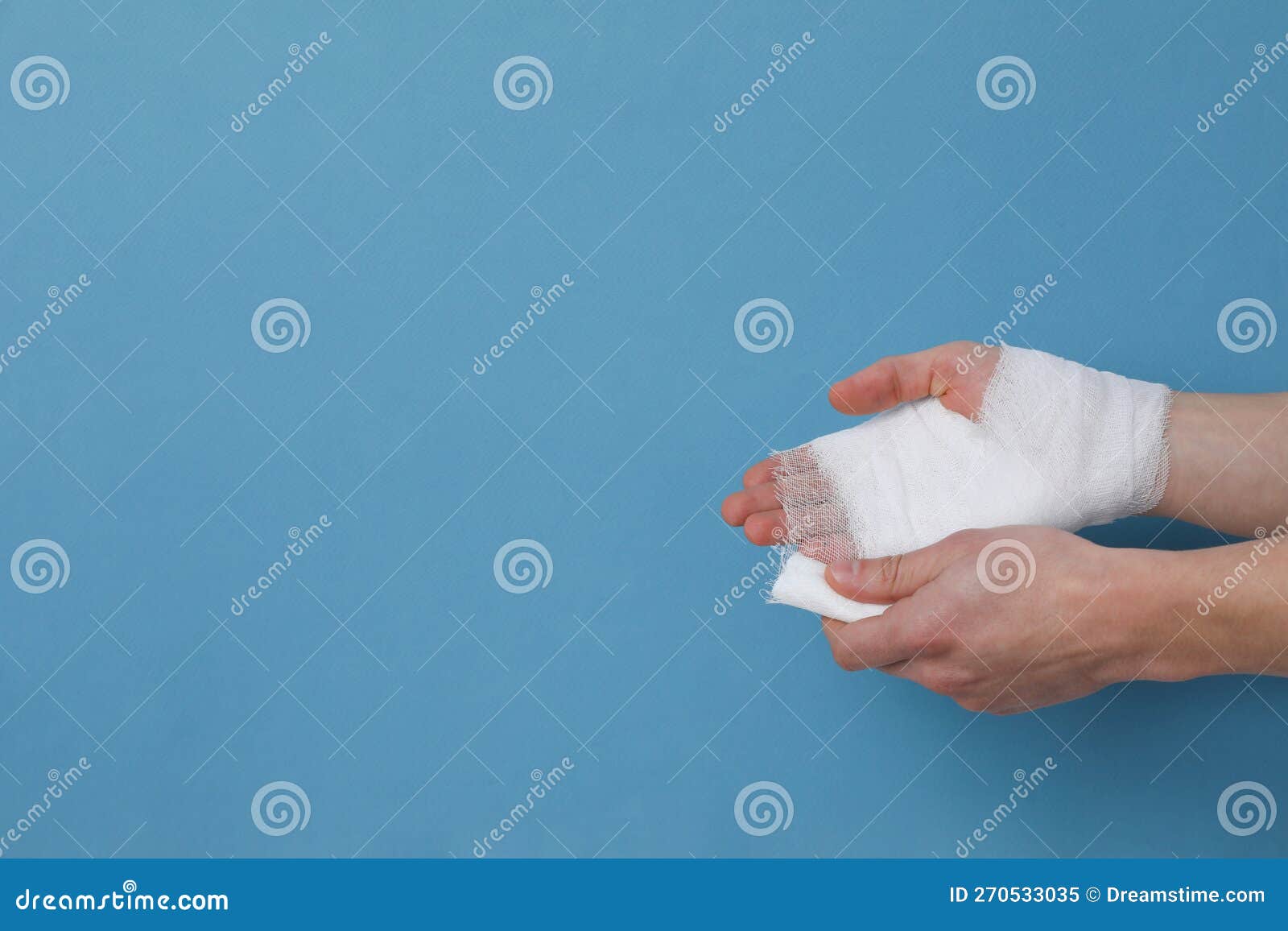 Concept of Help during an Injury, Man Wrapping Hand in Bandage on Blue ...