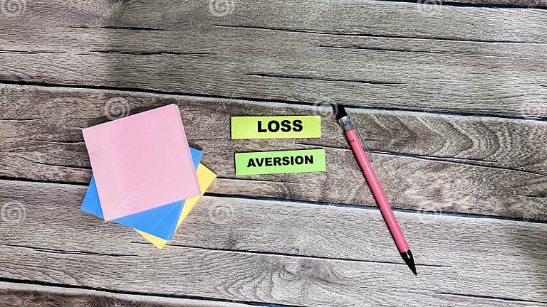 Concept of Loss Aversion Write on Sticky Notes Isolated on Wooden Table ...