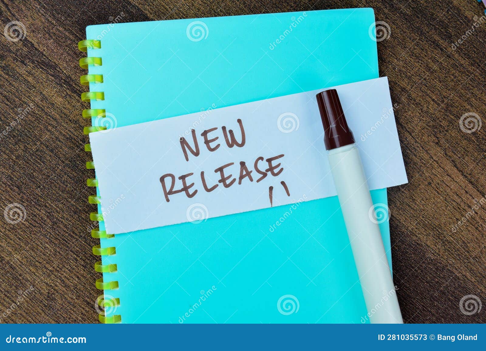 Concept of New Release Write on Sticky Notes Isolated on Wooden Table ...