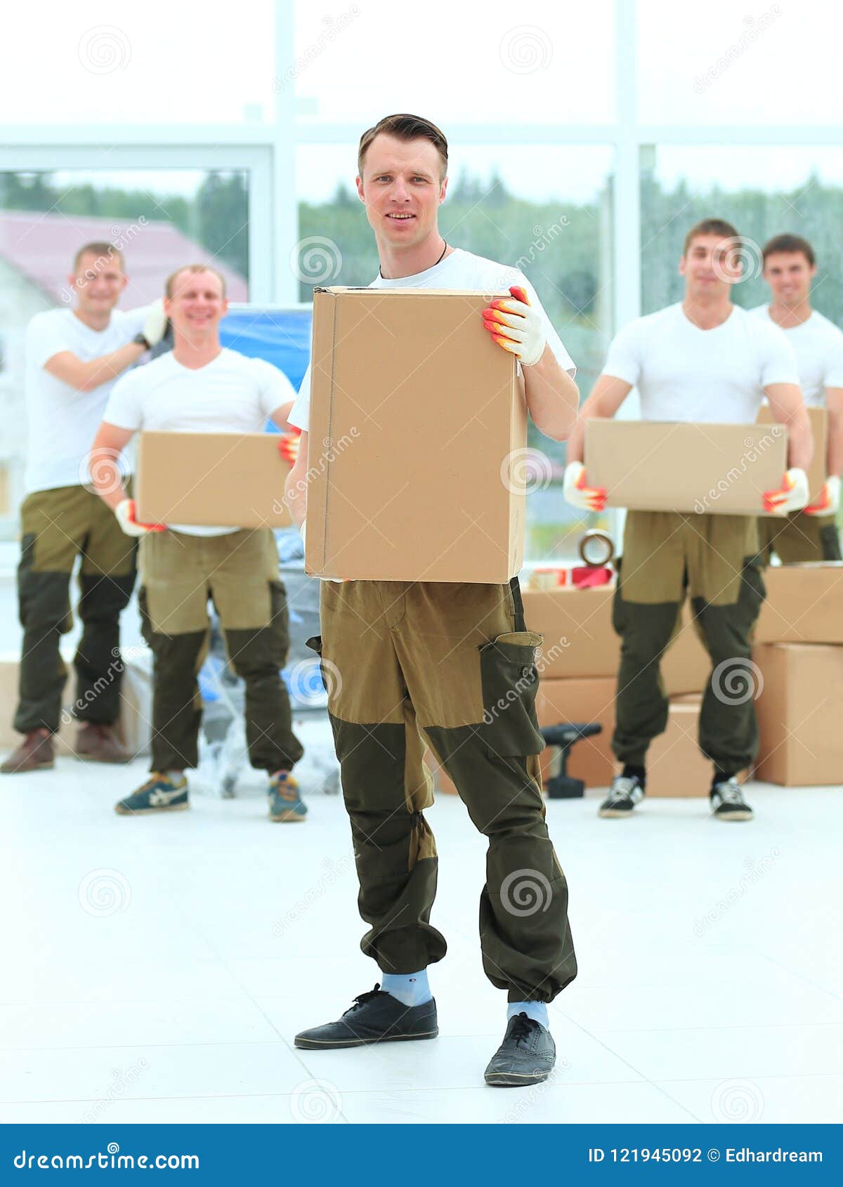 Foreman and Workers with Boxes of Building Materials Stock Photo ...