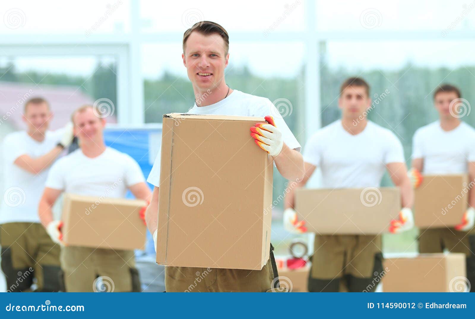Foreman and Workers with Boxes of Building Materials Stock Photo ...
