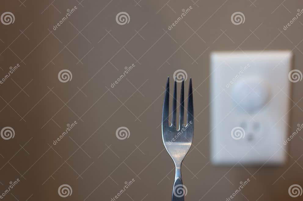 Selective Focus on Edge of a Metal Fork about To Be Inserted into an ...
