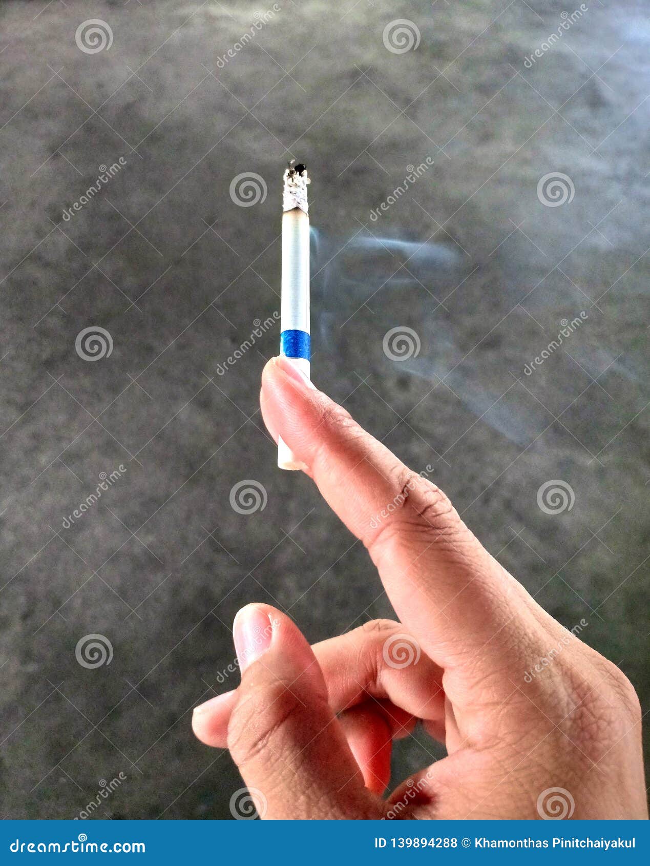Smoking Cigarette in hand stock photo. Image of health - 139894288