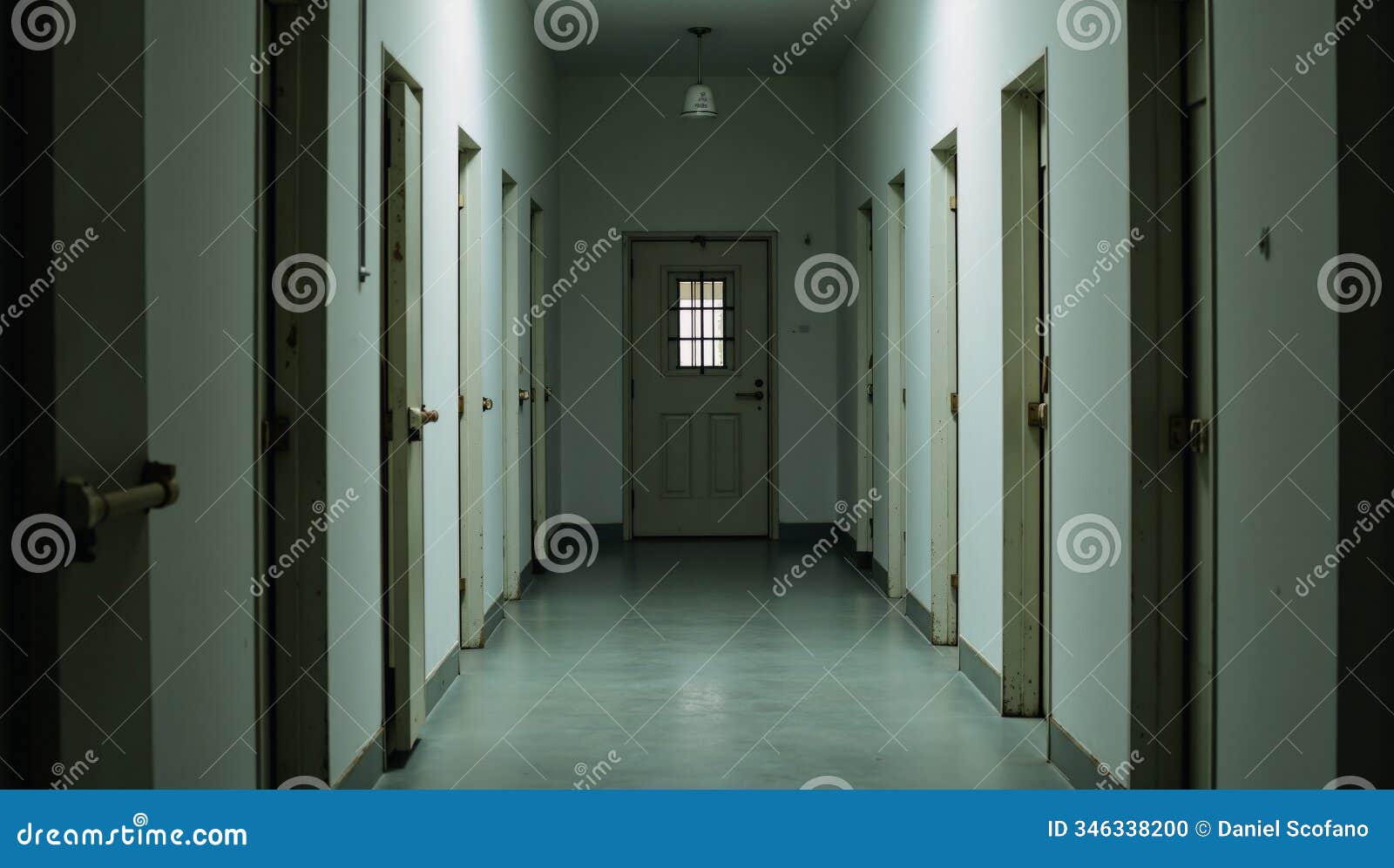A Stark Isolated Prison Corridor Featuring Dimly Lit Cell Doors ...