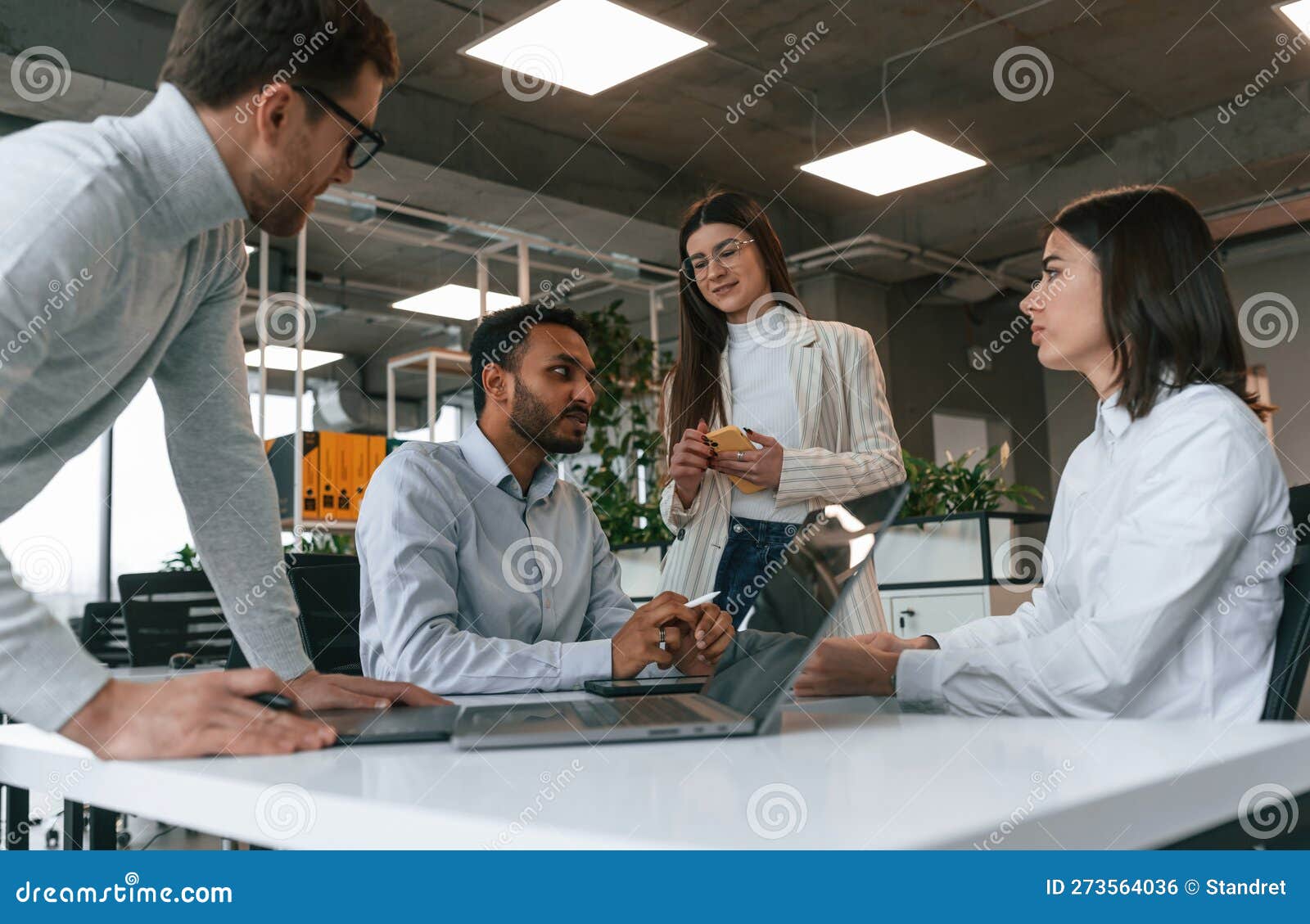 Conception of Teamwork. Four People are in the Office Together Stock ...