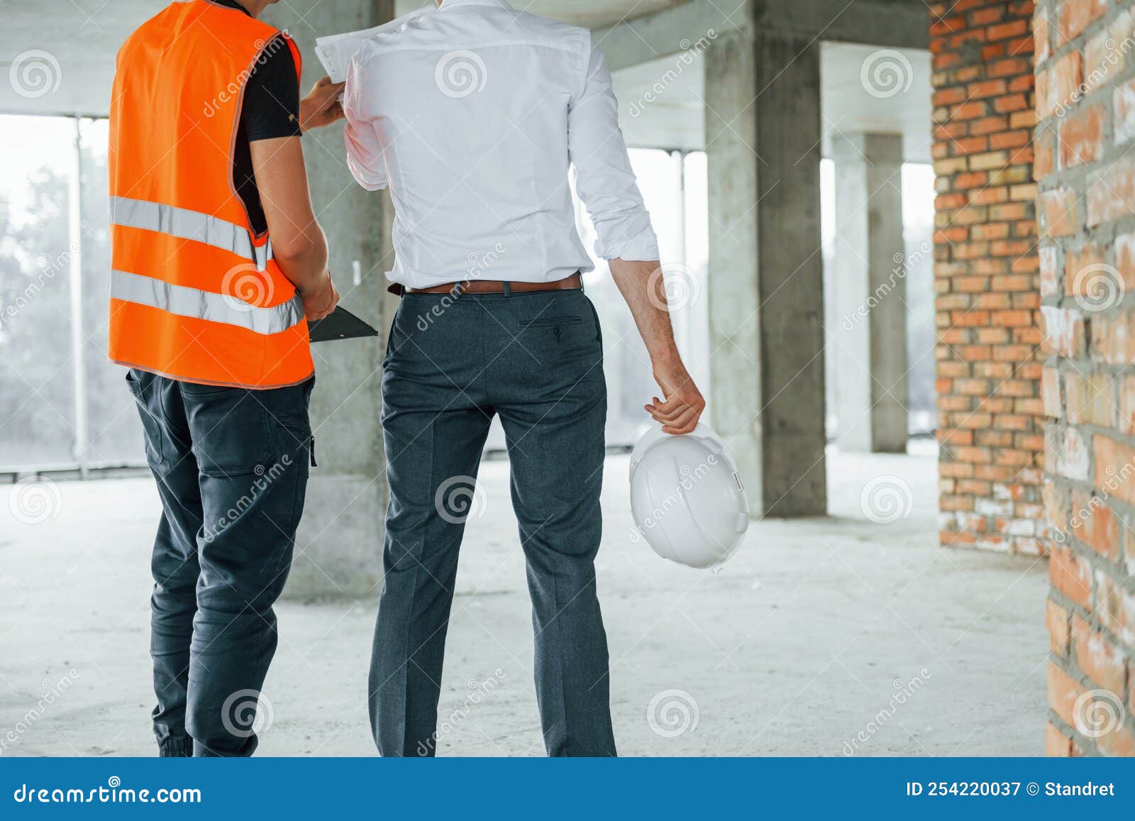 Conception of Teamwork. Man in Suit and Handyman in Orange Protective ...