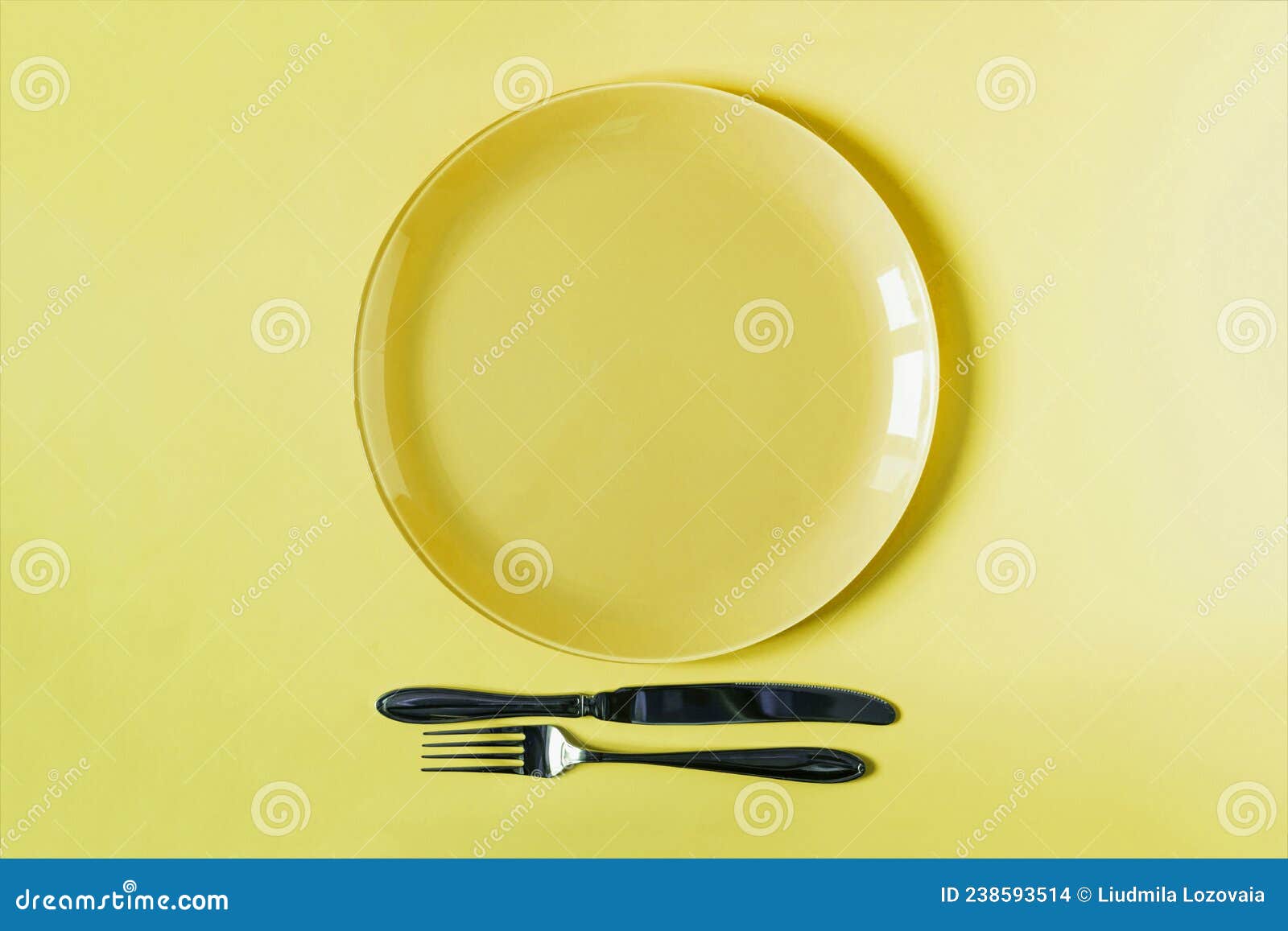 Conceptual Table Setting with a Large Yellow Plate and Cutlery on a ...