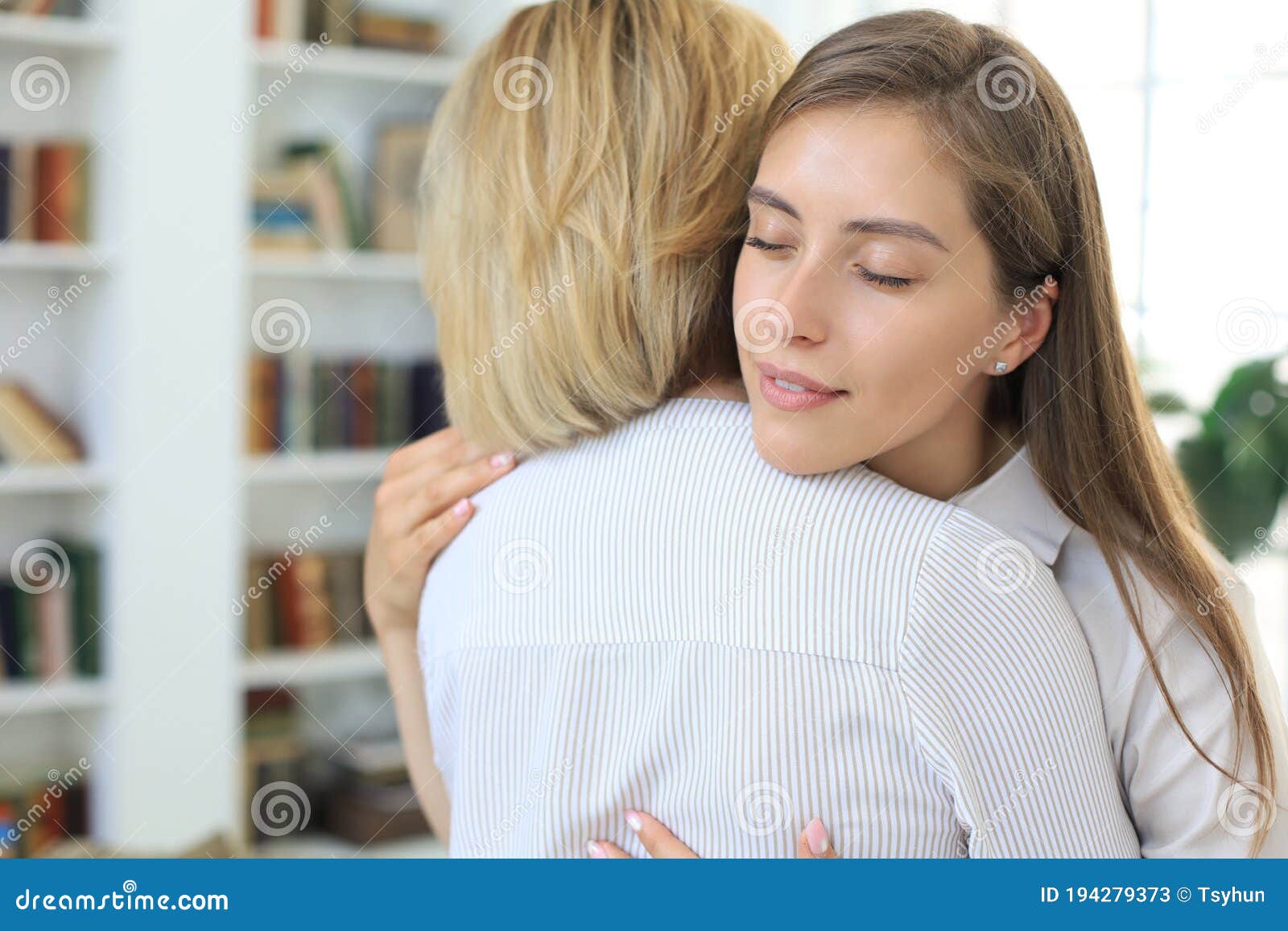 Concerned Middle Aged Mother Hugging Her Adult Daughter Listen Her