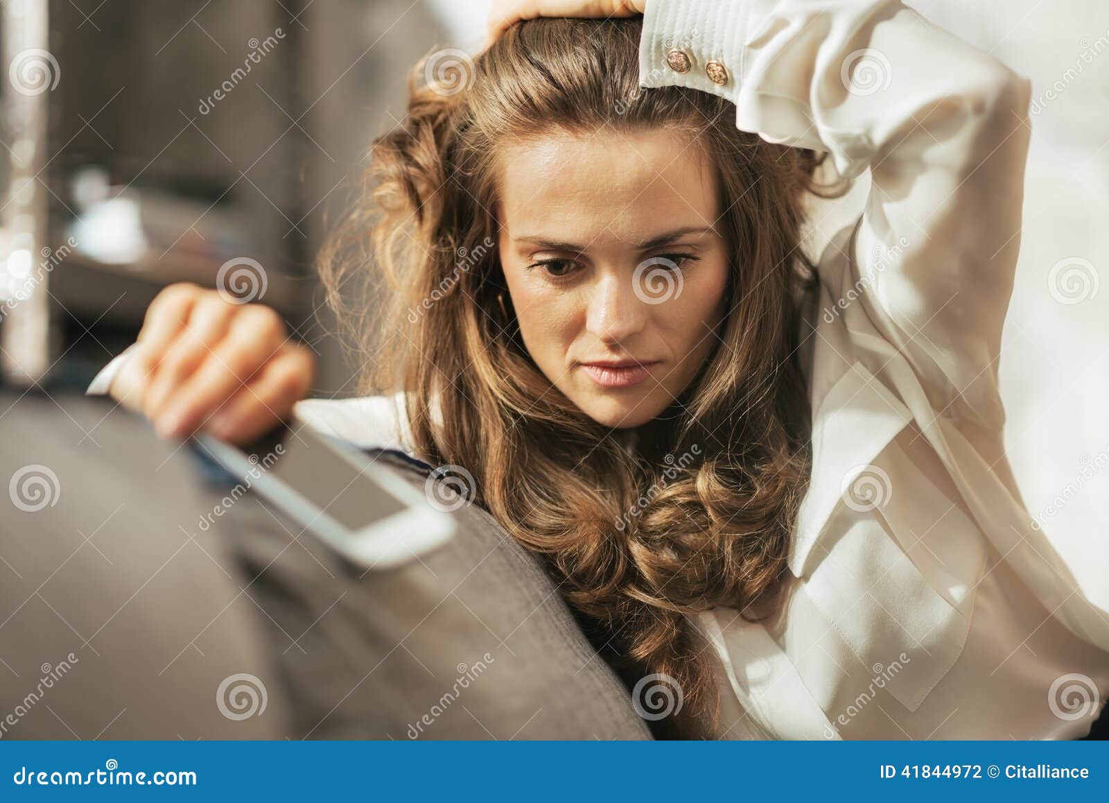 Concerned Woman with Cell Phone Sitting on Couch Stock Photo - Image of ...