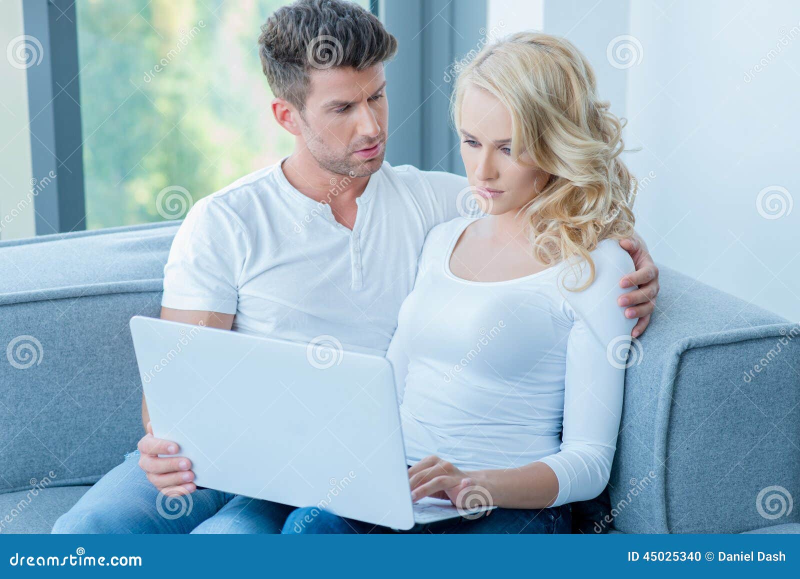 Concerned Young Couple Using a Laptop Computer Stock Photo - Image of ...
