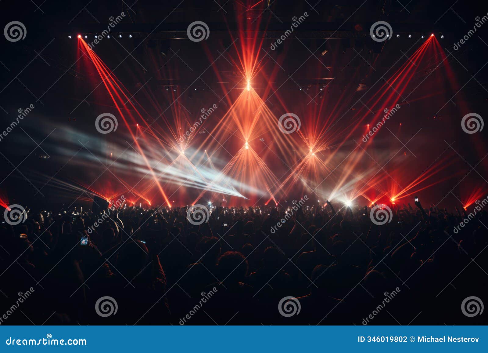 Concert Crowd in Front of Bright Stage in the Rays of Spotlights and ...