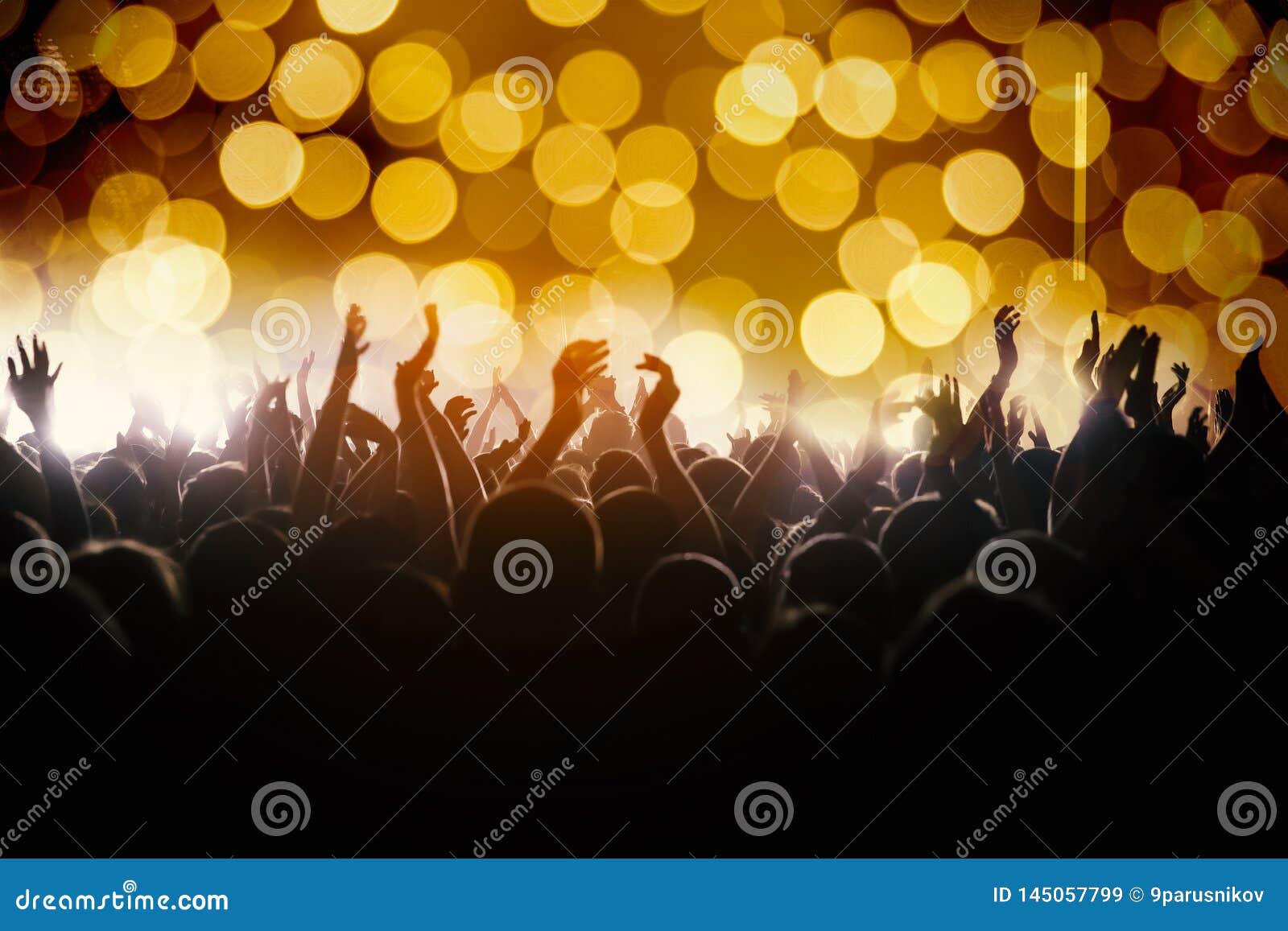 Concert Hall with a Lit Stage and People Silhouettes during a Concert ...