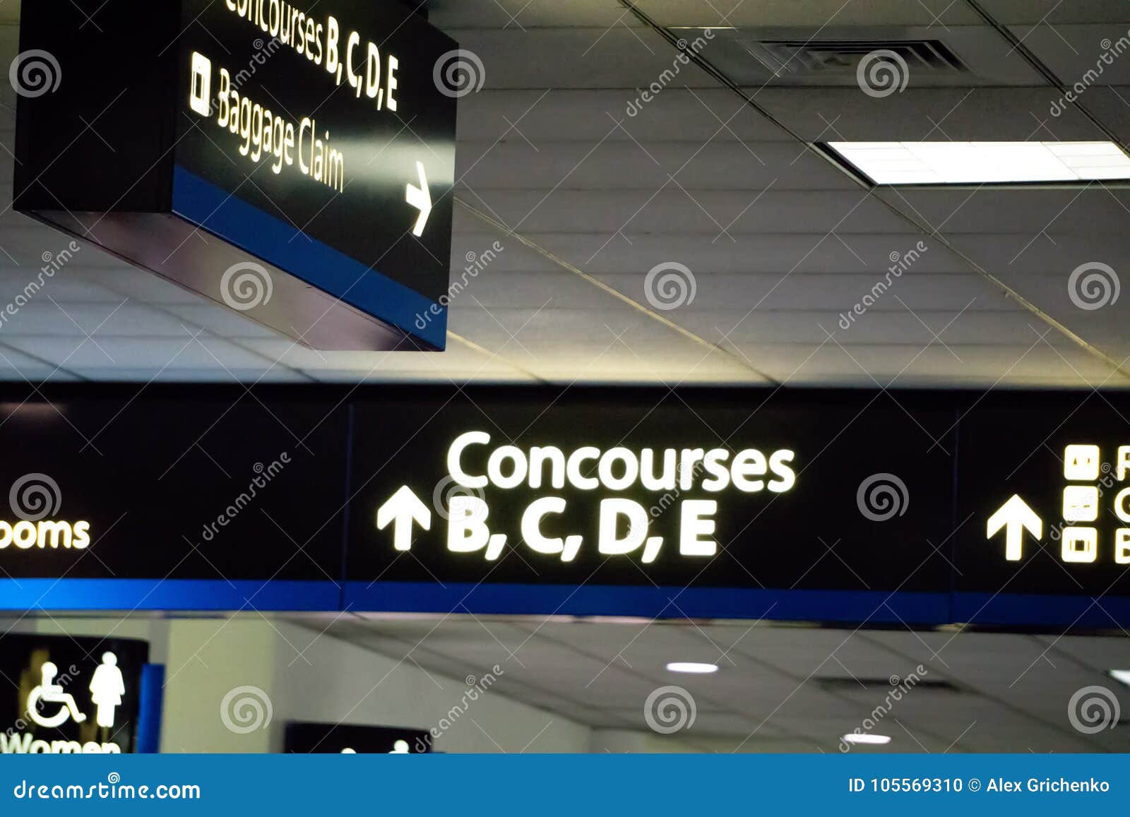 Concourse Sign and Directional Arrows at an Airport Stock Photo - Image ...