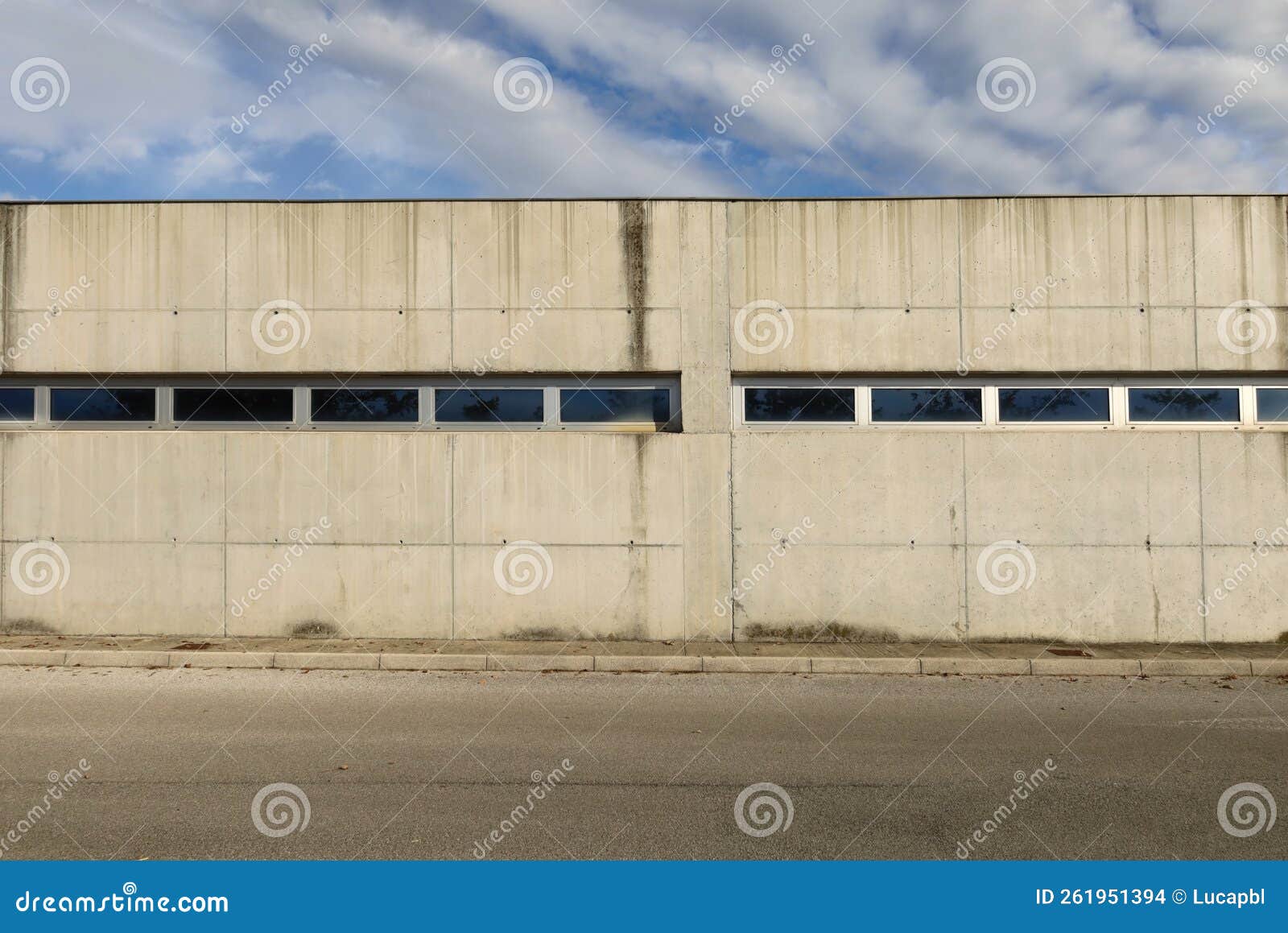 Concrete Block Wall with a Row of Small Windows in the Upper Side ...