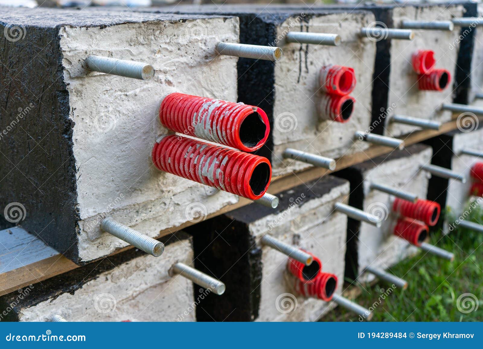 Concrete Blocks with a Red Pipe Inside. Laying of Communications ...