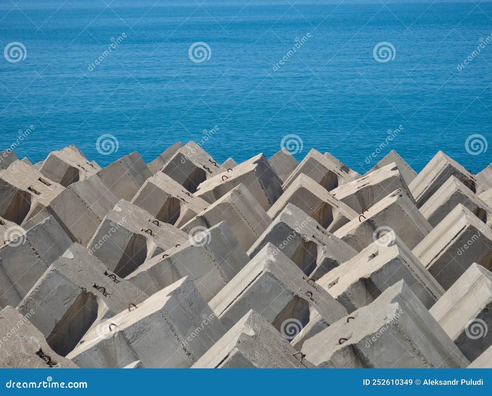 Concrete Breakwaters and Heaps of Stones on the Shore. Stone Against ...
