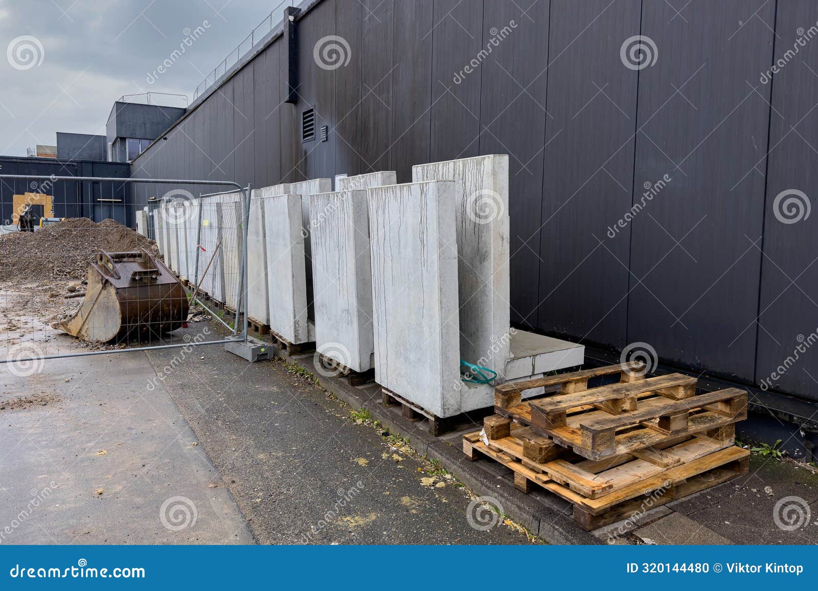 Concrete Building Blocks and Excavator Buckets on Construction Site ...