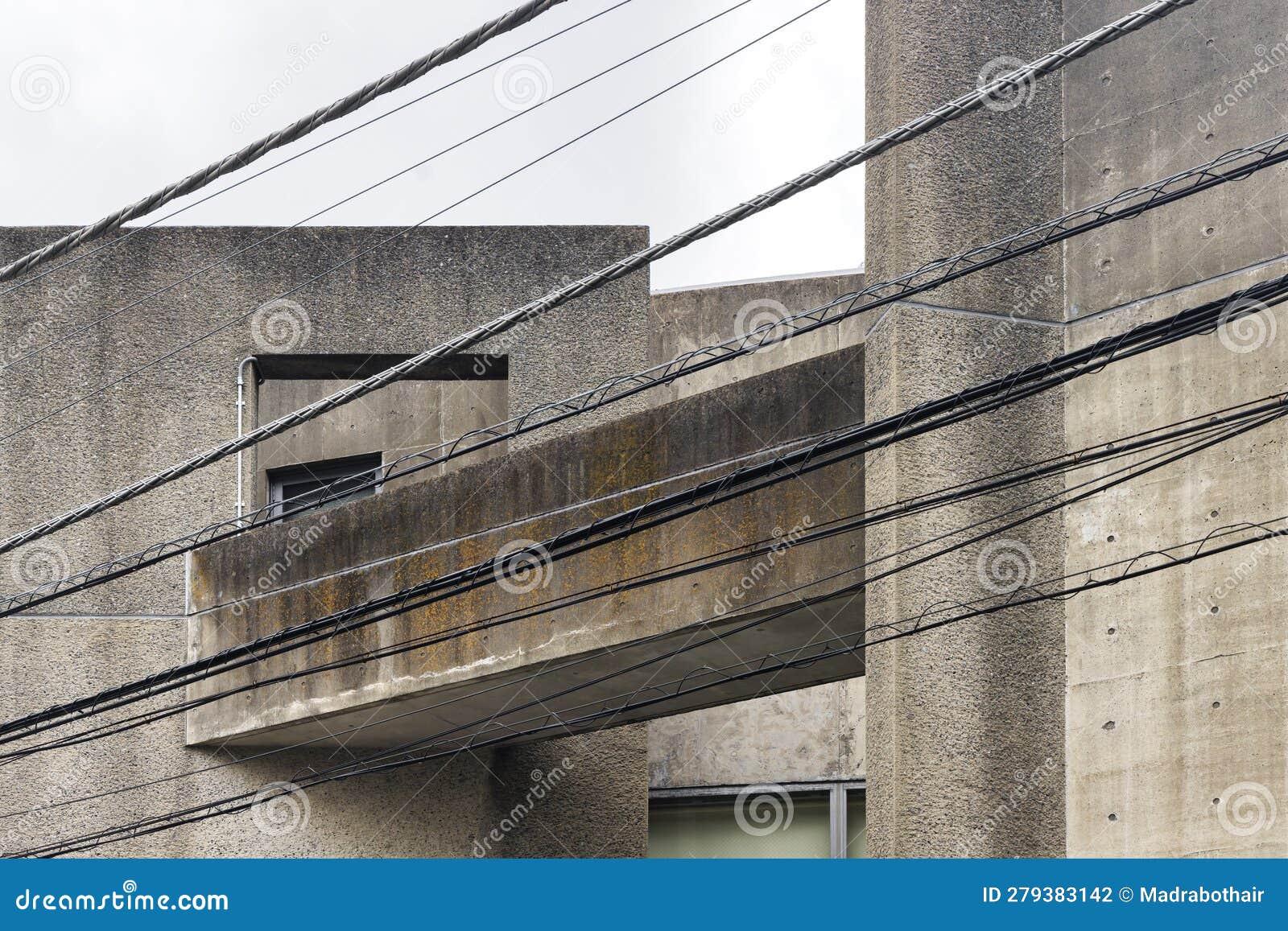 Concrete Building with Overhead Powerlines in Front Stock Photo - Image ...