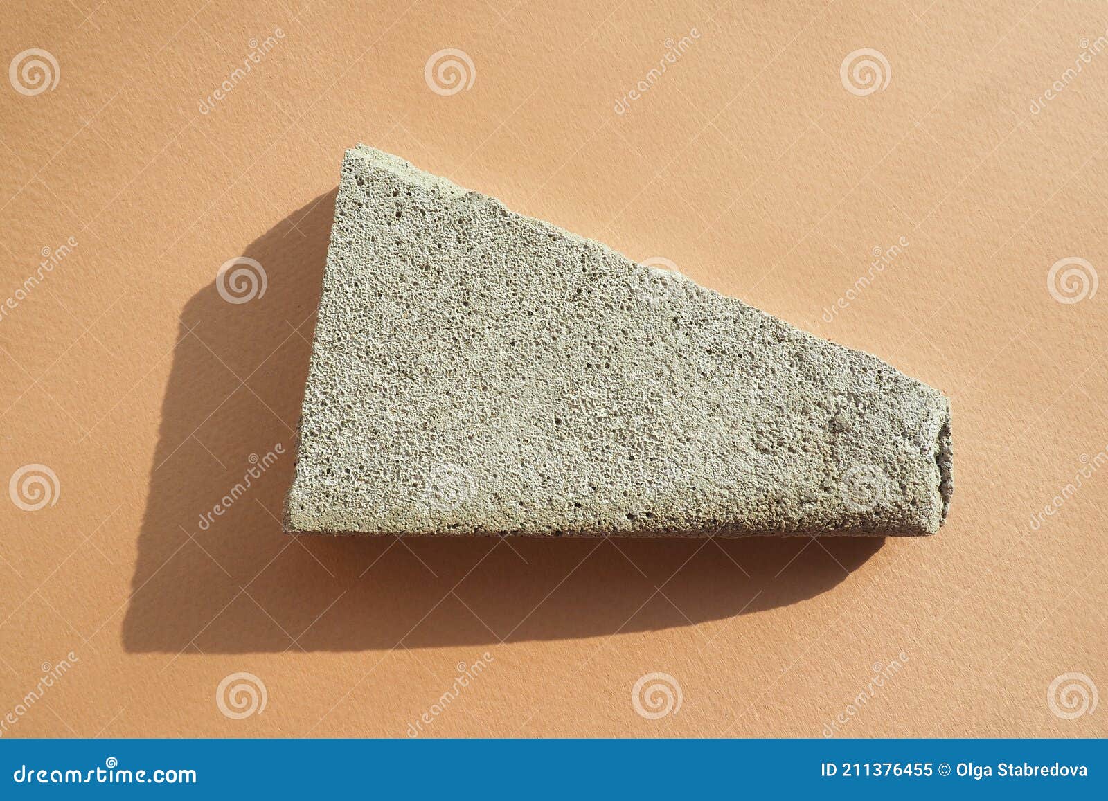 Concrete Chip on a Beige Paper Background in Harsh Light with Shadows ...