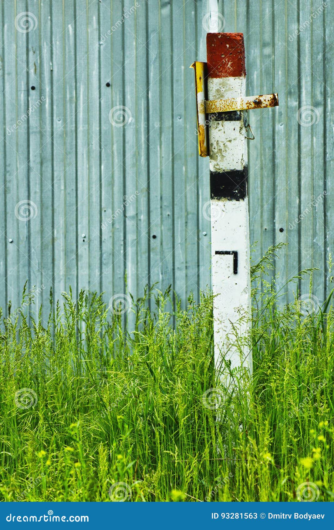 A Concrete Column in the Grass Near the Fence Stock Image - Image of ...