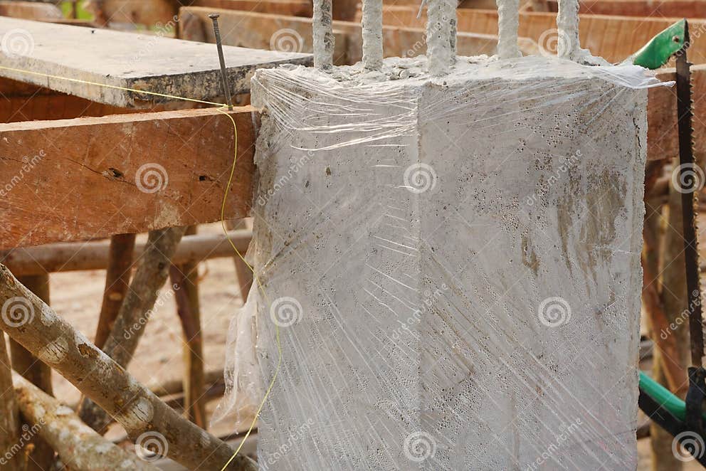 Concrete Columns at the Construction Site are Covered with Plastic ...